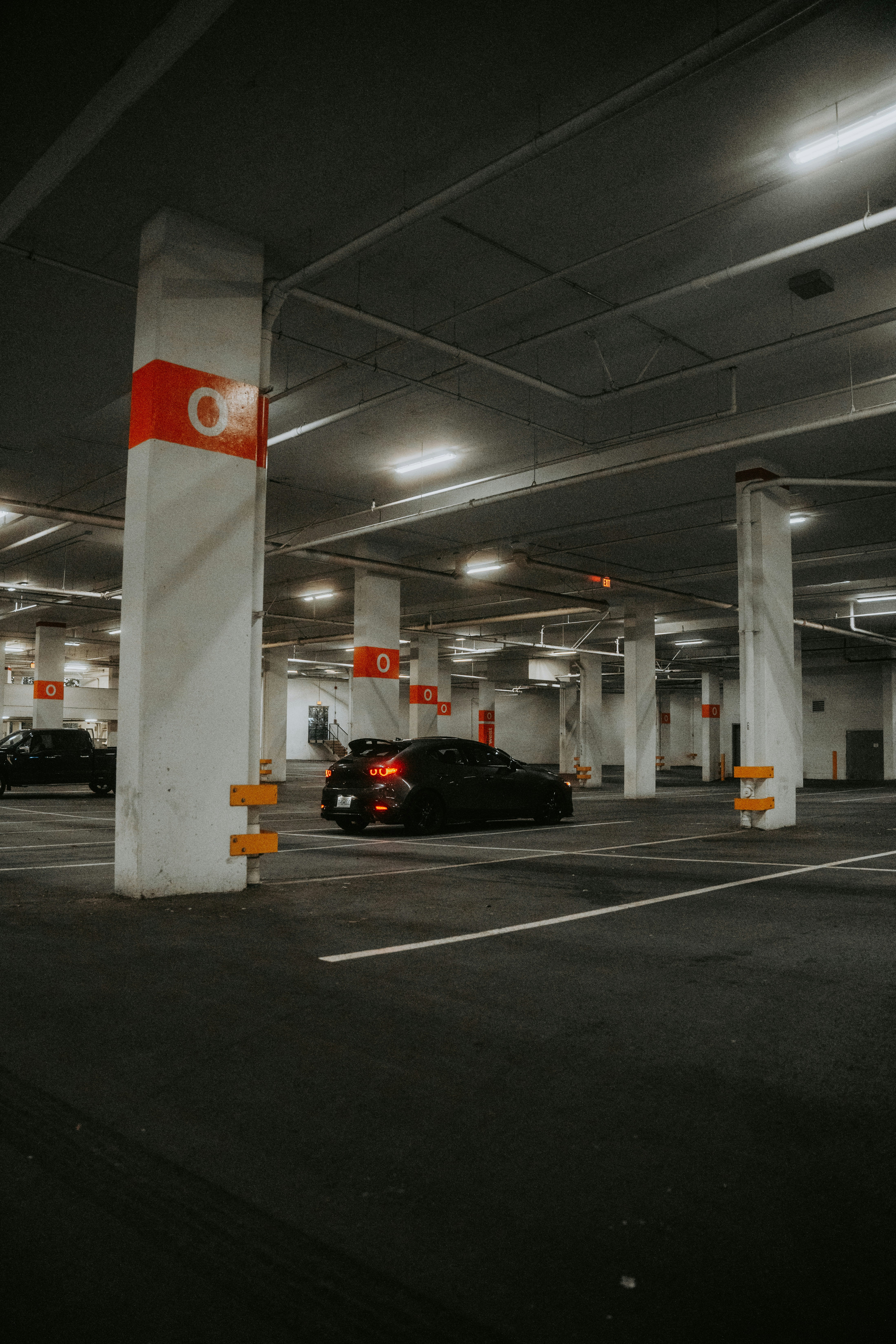 Midnight Cipher: A Black Sedan Among Concrete Pillars