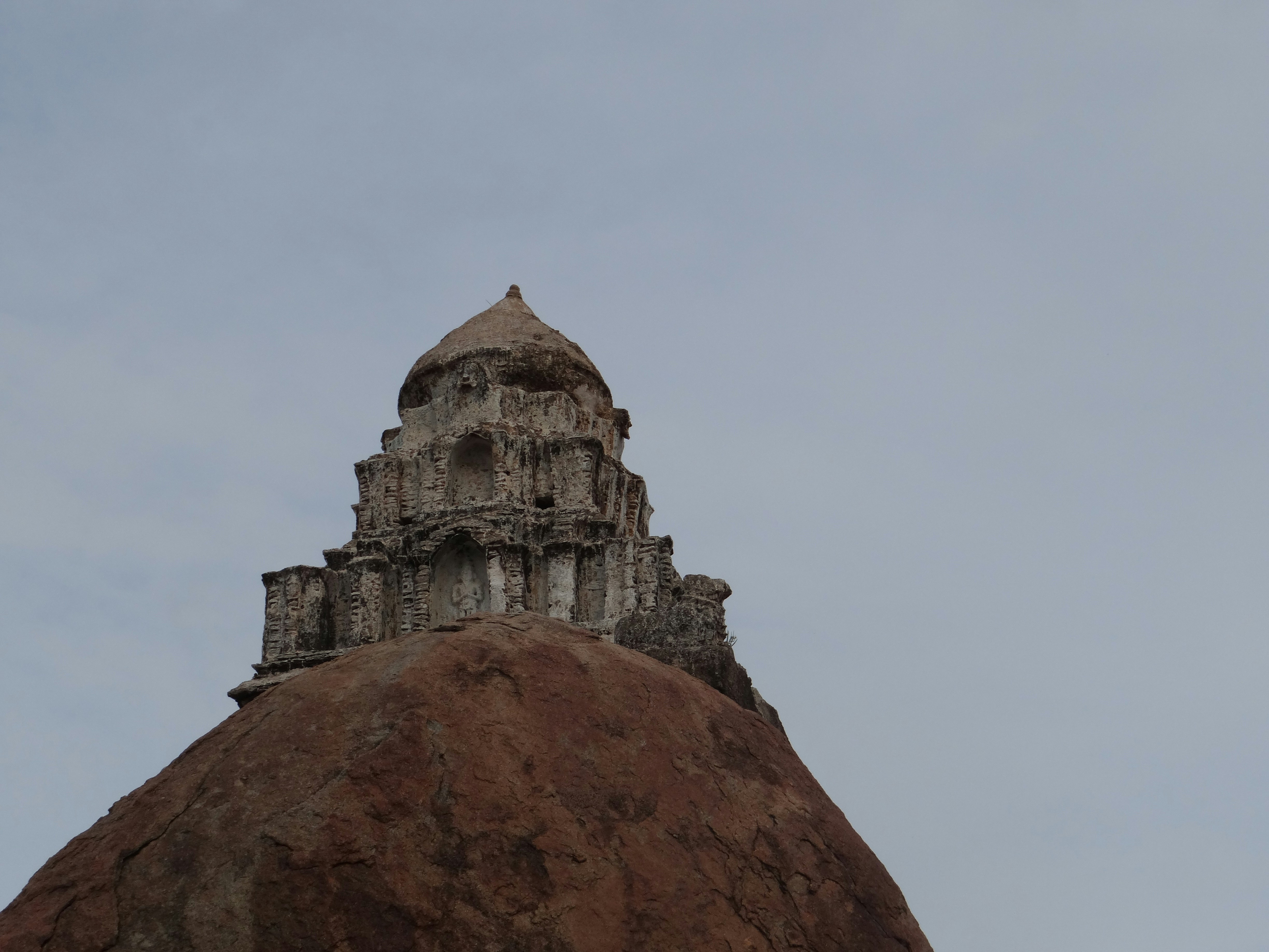 Red Hill Sentinel: A Weathered Turret Crowned by Stone