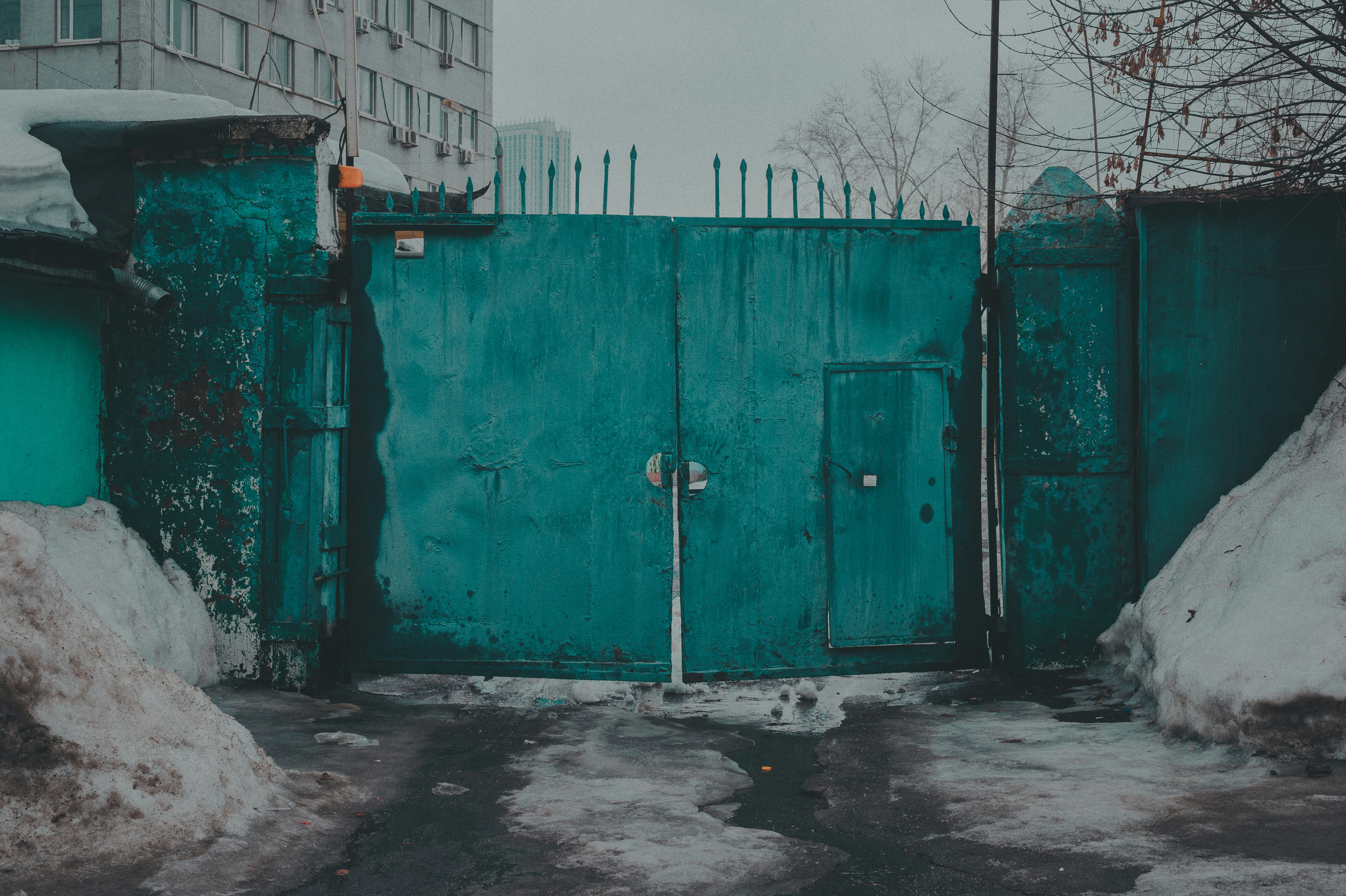 Teal Gate at Winter's Edge: An Urban Threshold