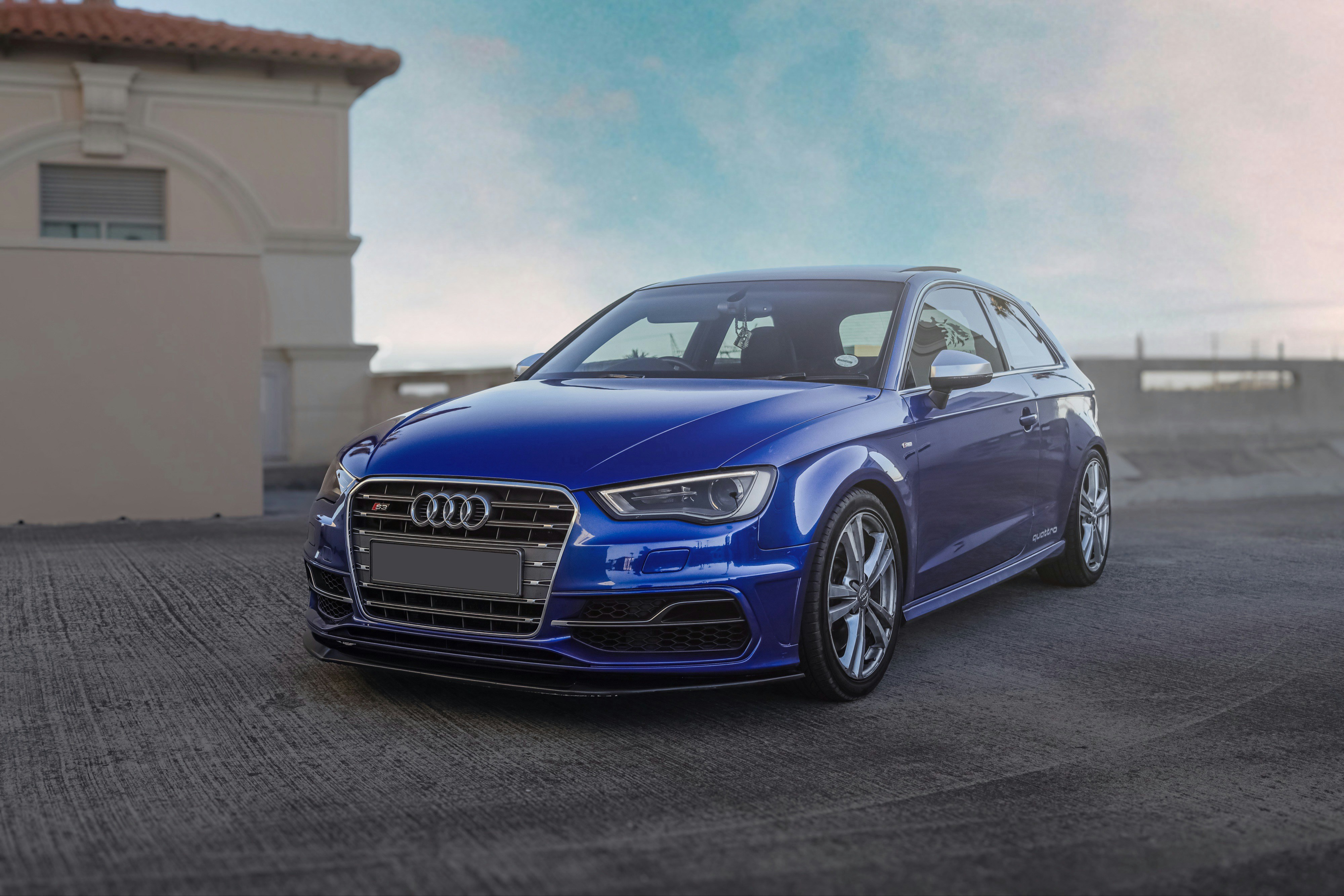 A blue car parked in front of a building photo – Free Audi Image on ...