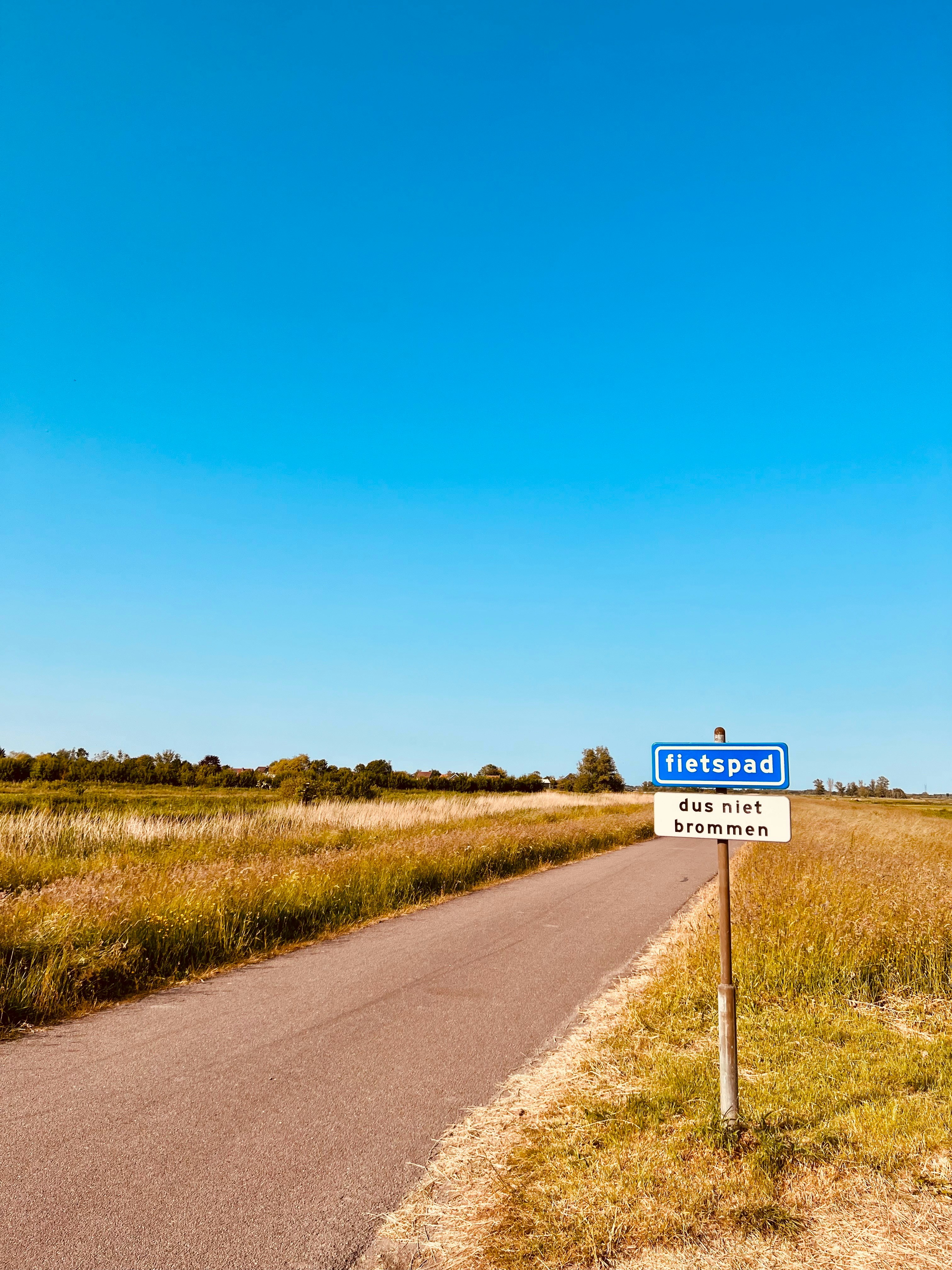 Blue Fietspad Sign Marks a Quiet Dutch Countryside Path