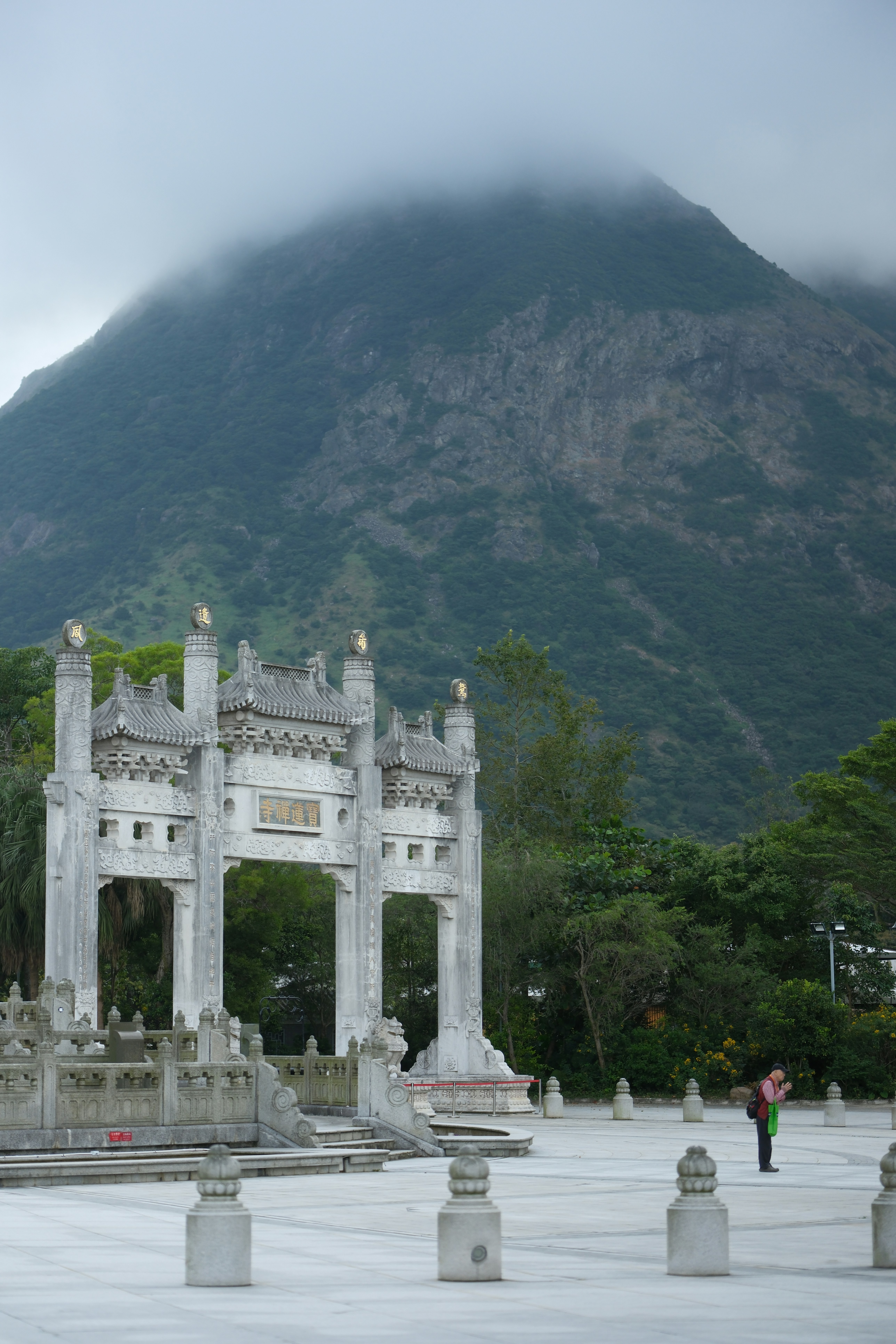 Stone Gate Framing a Mist-Softened Peak
