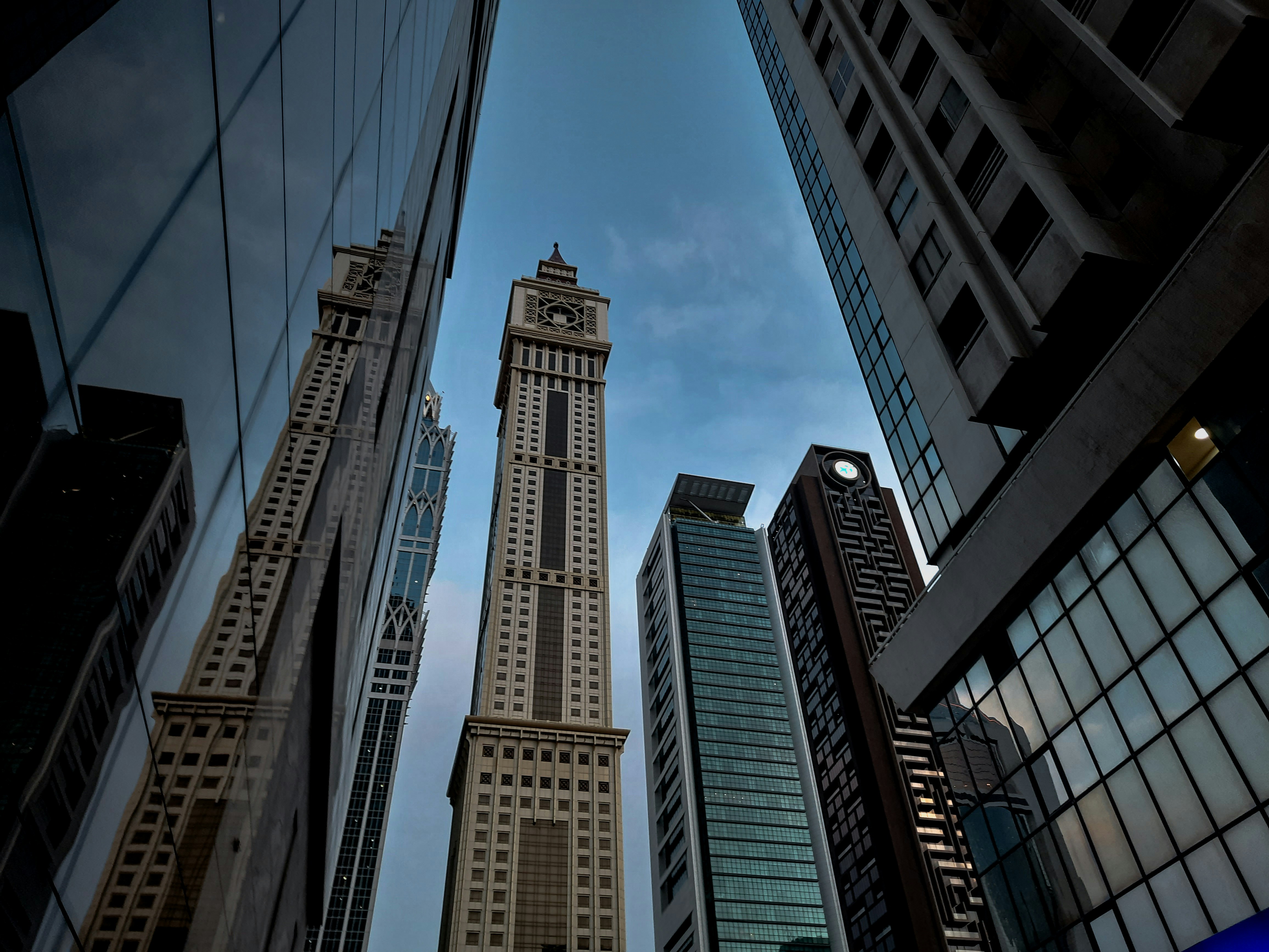 A very tall tower towering over a city filled with tall buildings photo ...