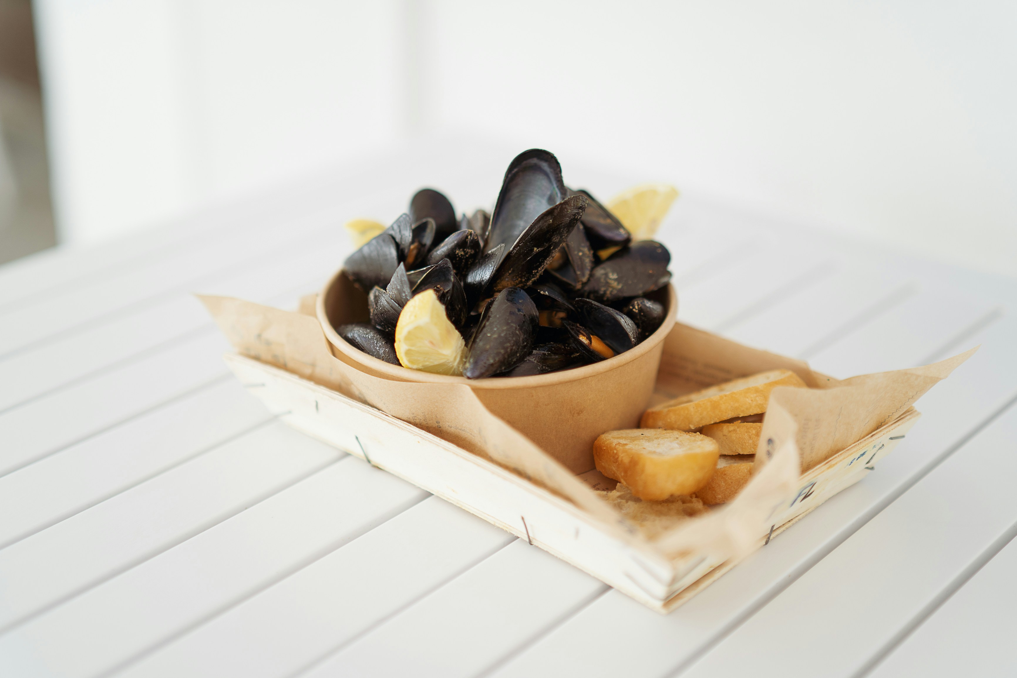 A bowl of mussels and fries on a table photo – Free Food Image on Unsplash