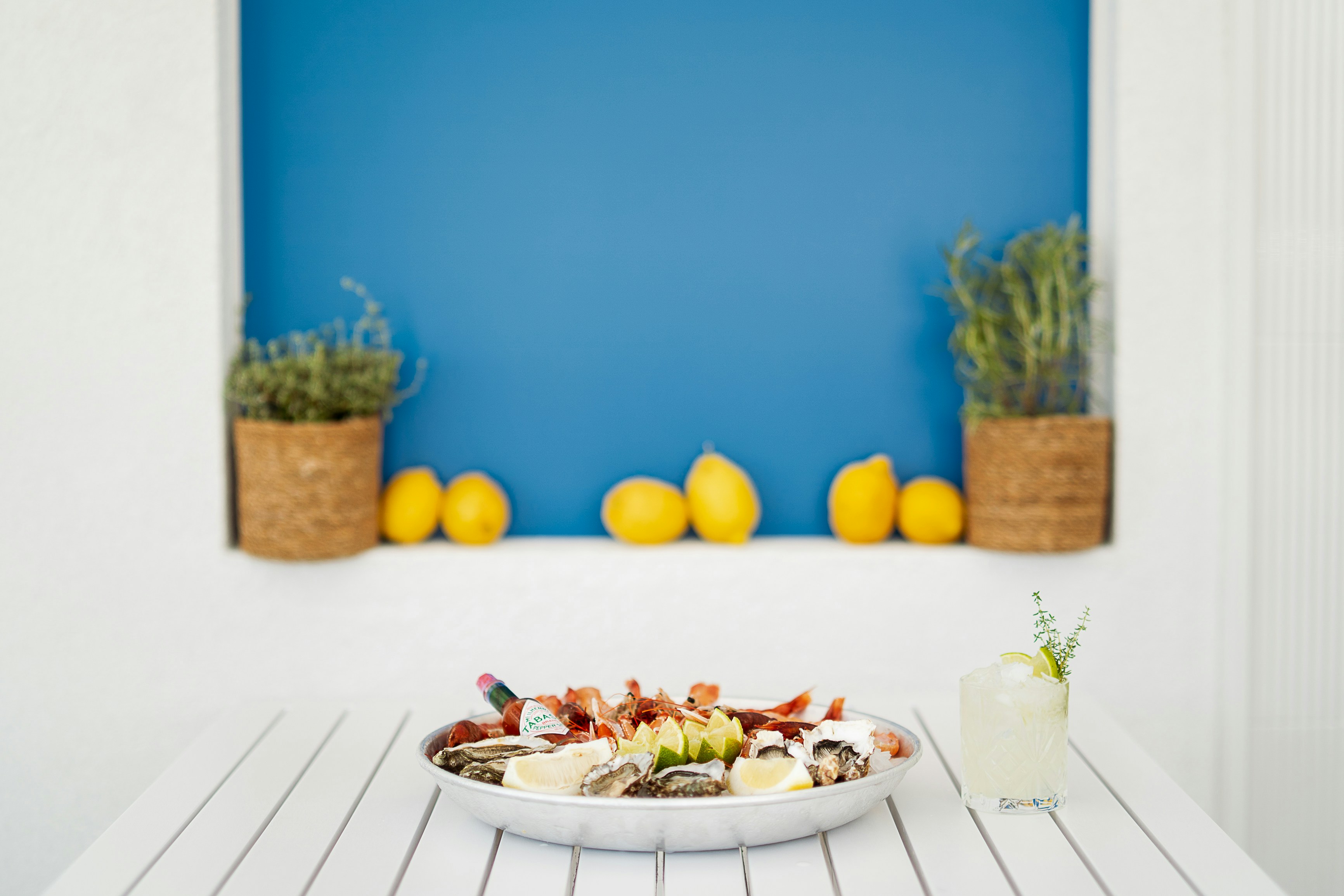 Sunlit Seafood Plate Framed by a Blue Kitchen Nook