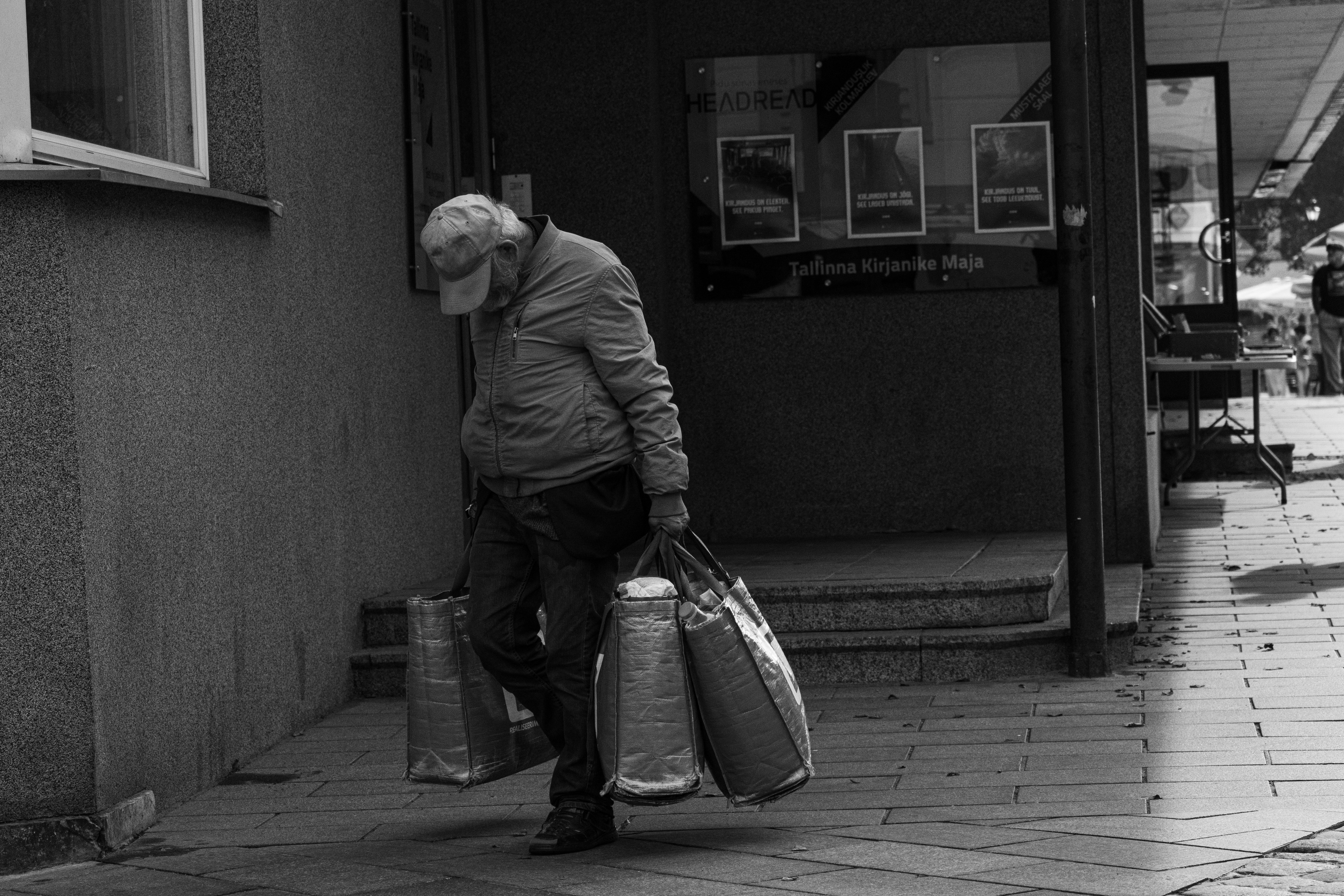 An old man carrying some filled bags in the city of Tallinn, Estonia.Jan Ledermann