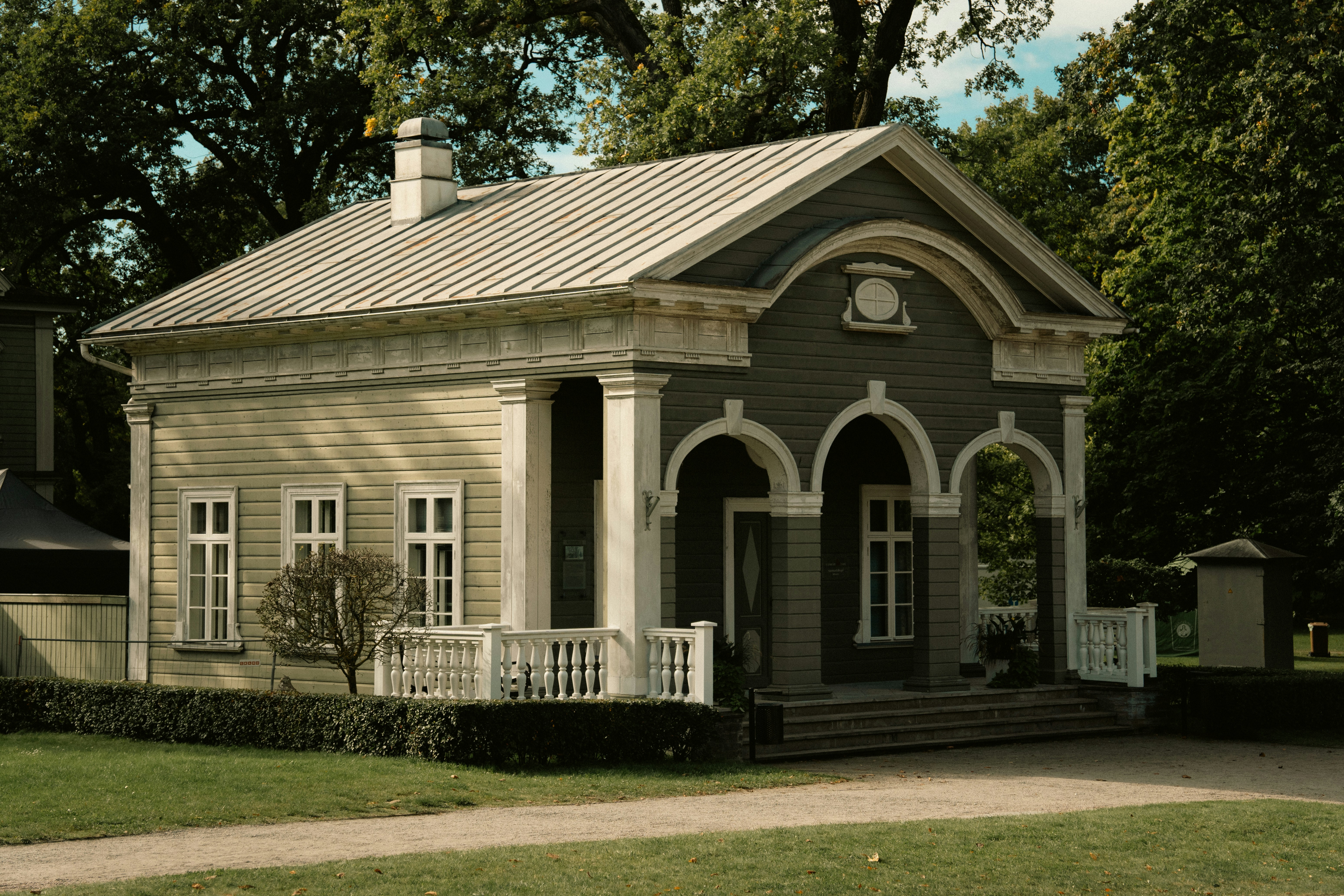 Arched Veranda of a Quiet Heritage House Bathed in Sunlight