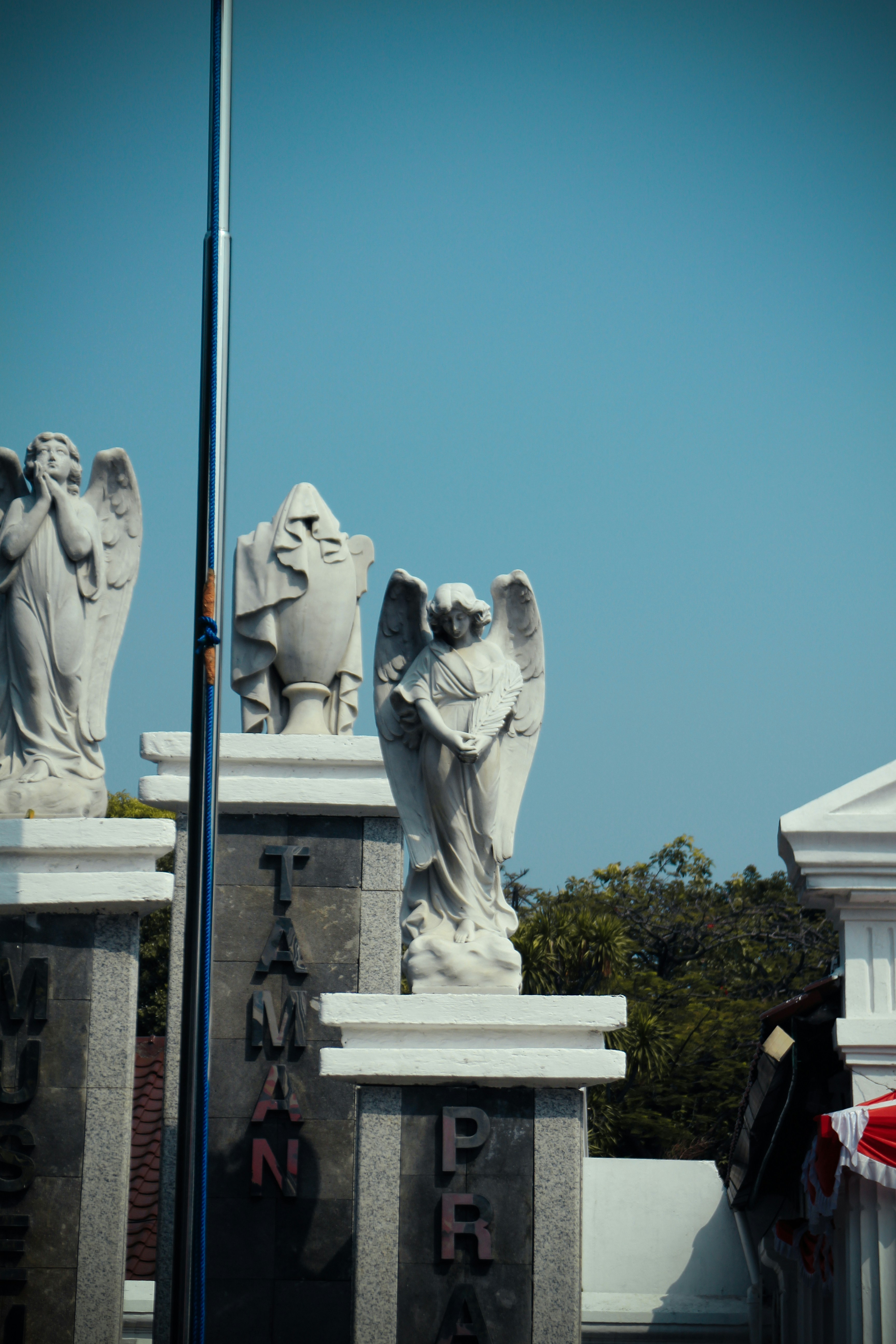 A group of statues sitting on top of cement pillars