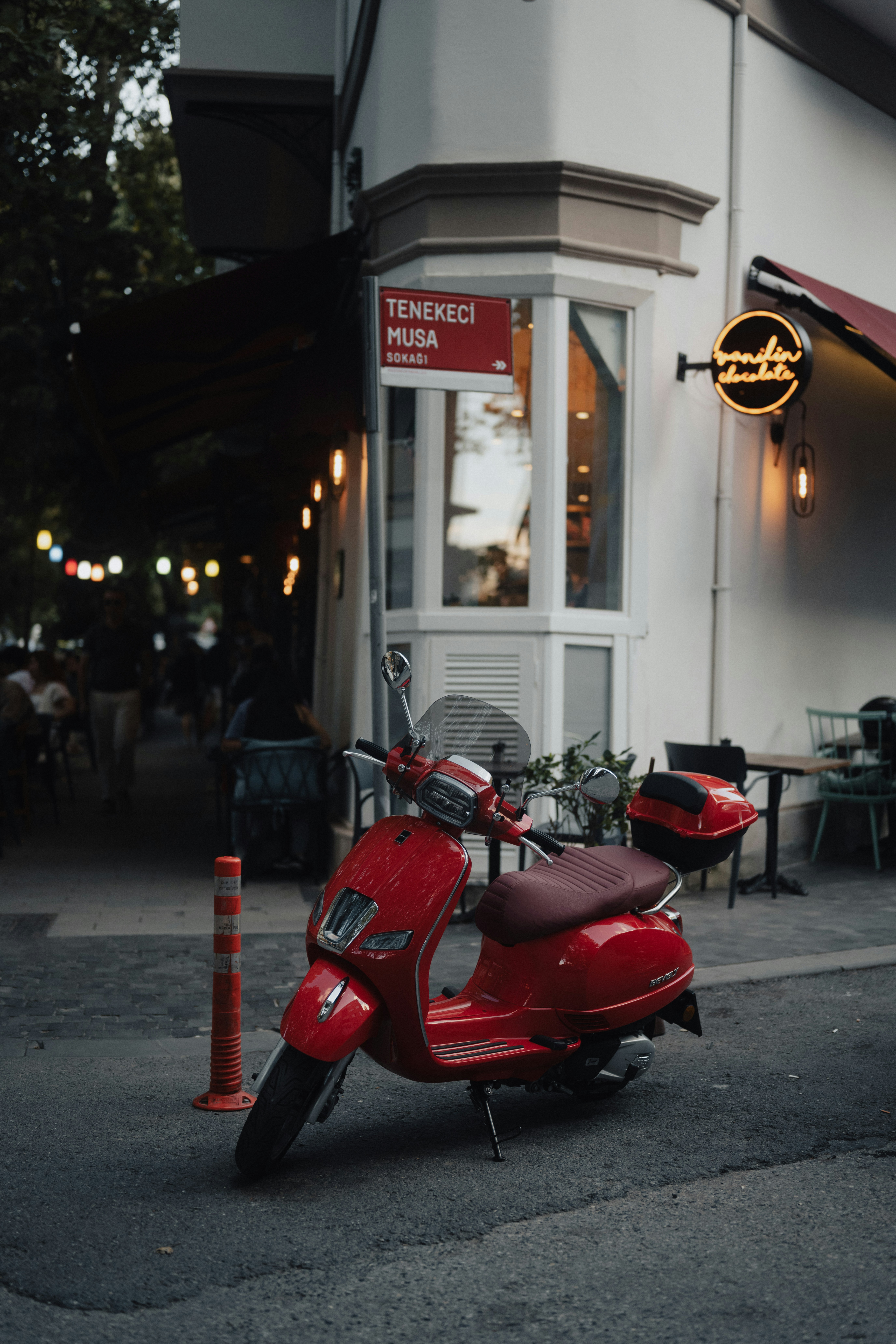 Red Vespa by a Lantern-lit Café on a Quiet Street