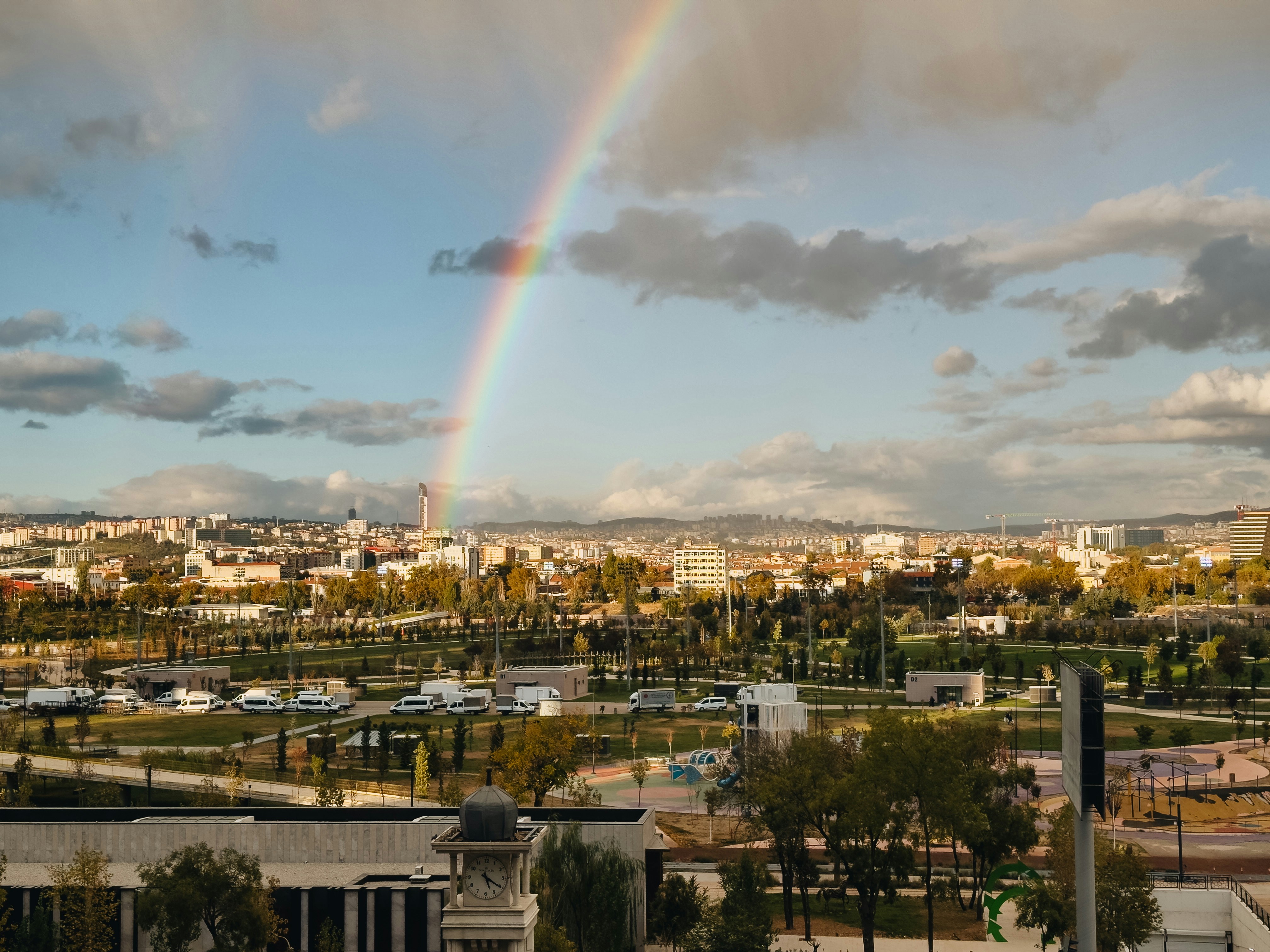 Rainbow Crossing: A Cityscape Framed by a Skyward Arc
