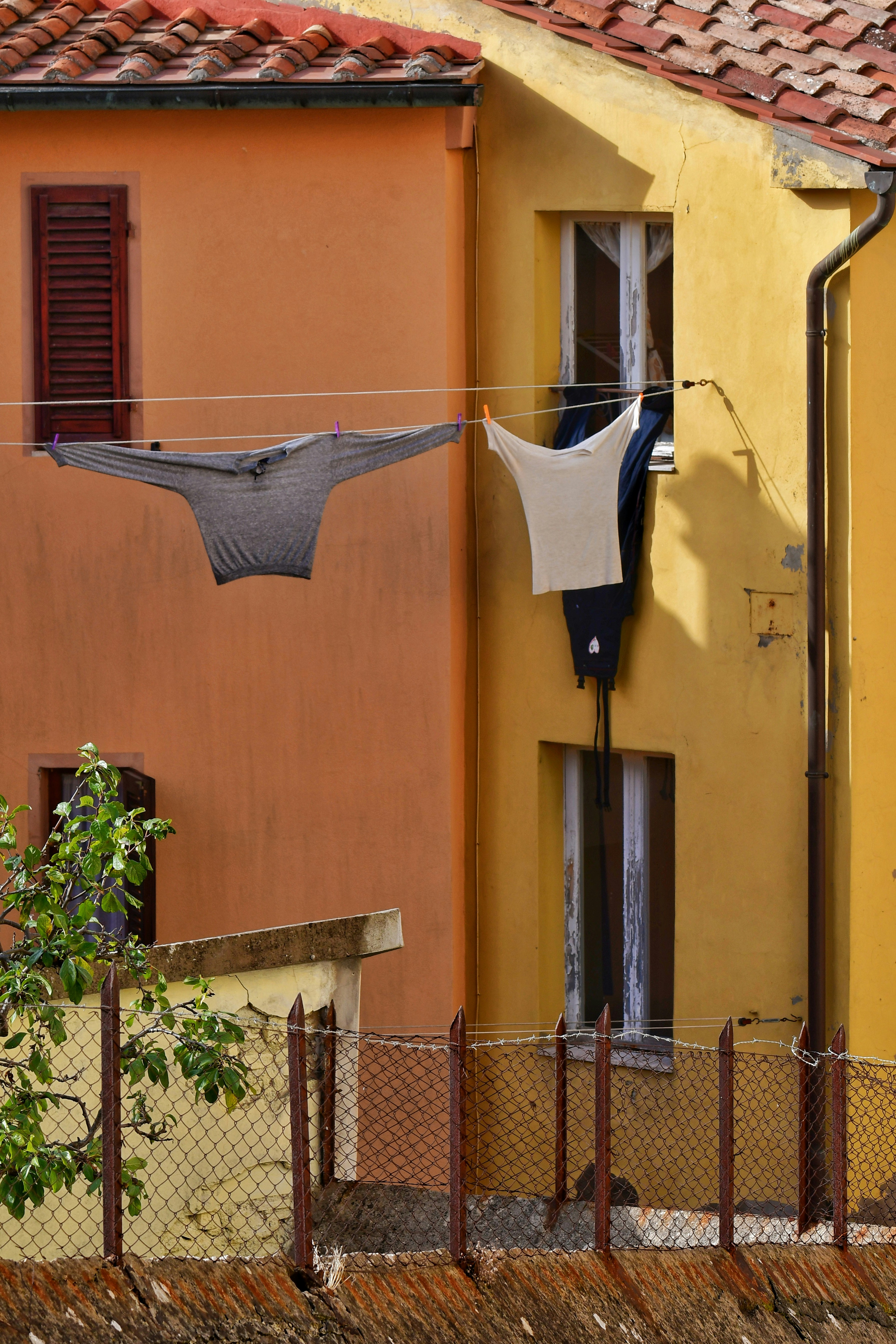 Laundry Across Ochre Facades in a Sunlit Courtyard