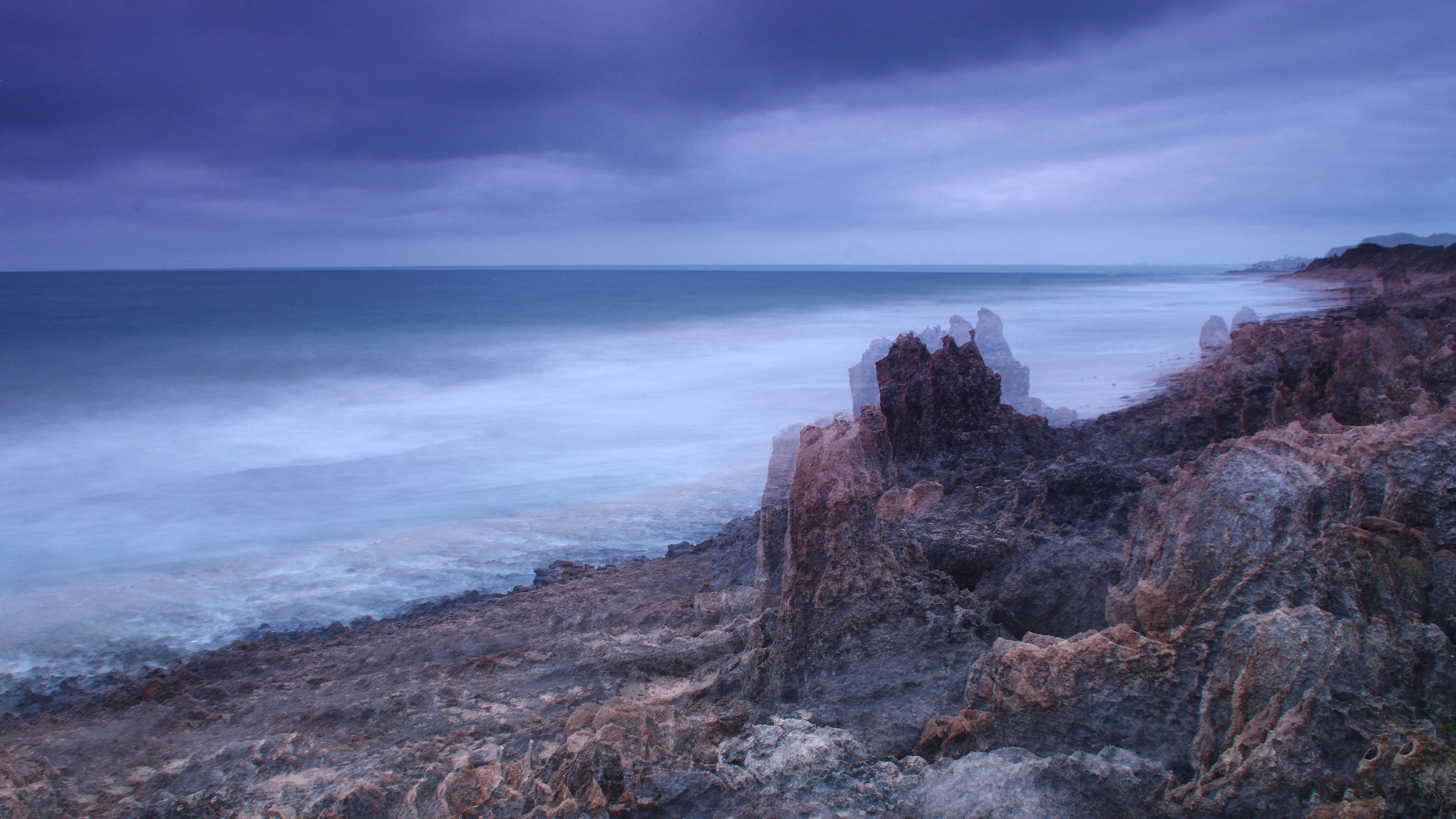 A blurry photo of the ocean and rocks photo – Free Rock pool bay Image ...