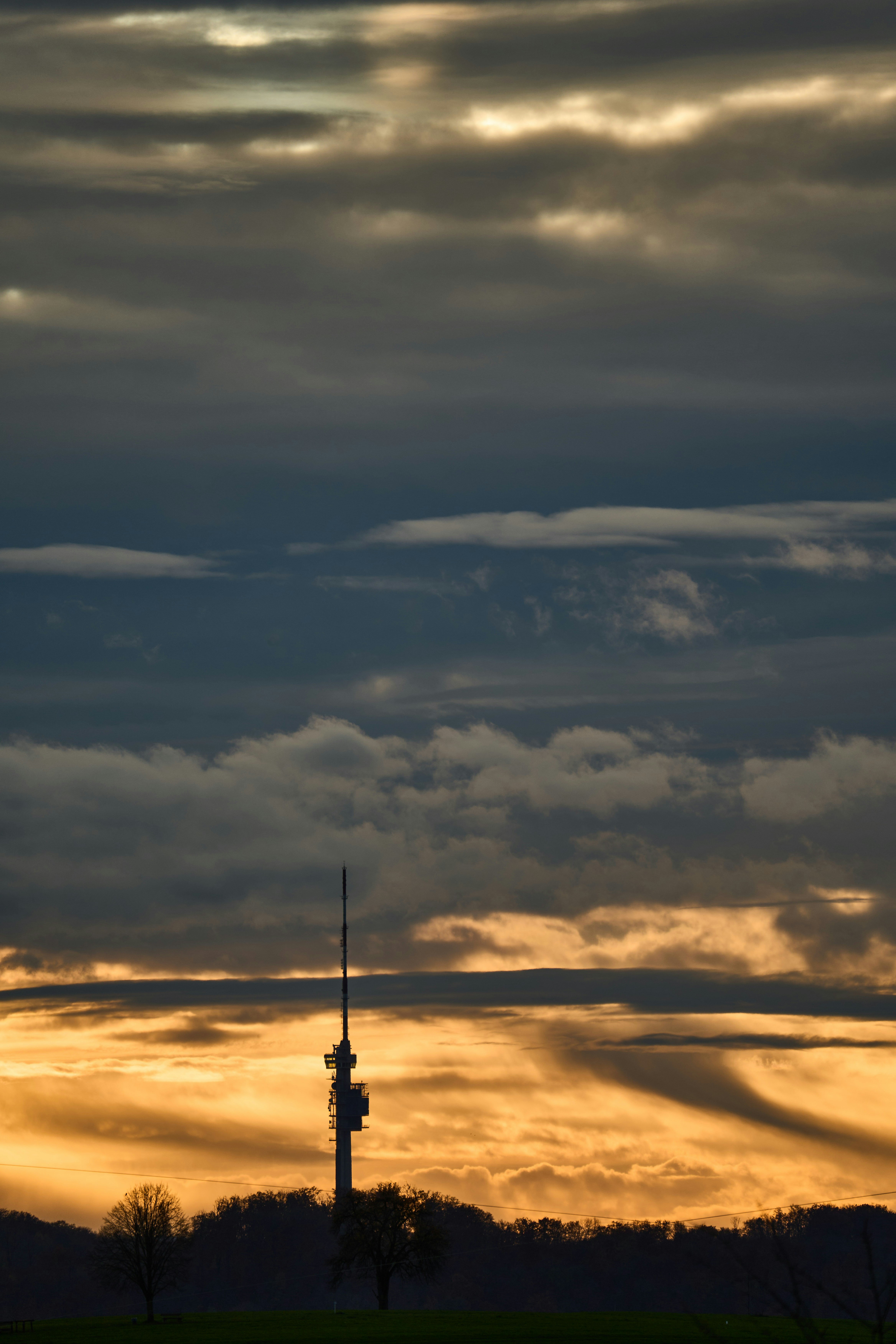 Silhouetted Tower at Sunset: A Quiet Horizon Between Light and Shade