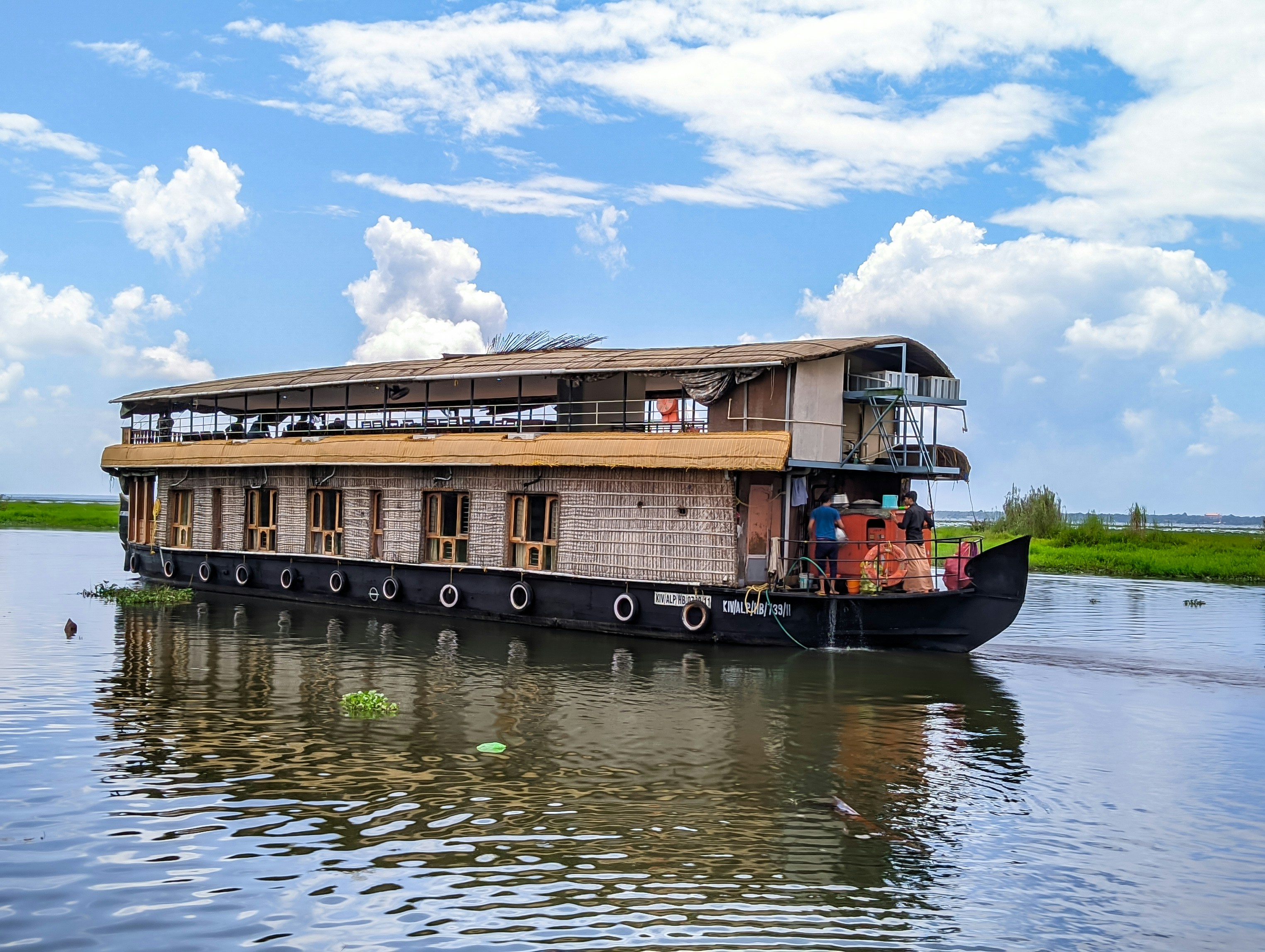 A house boat floating on top of a body of water