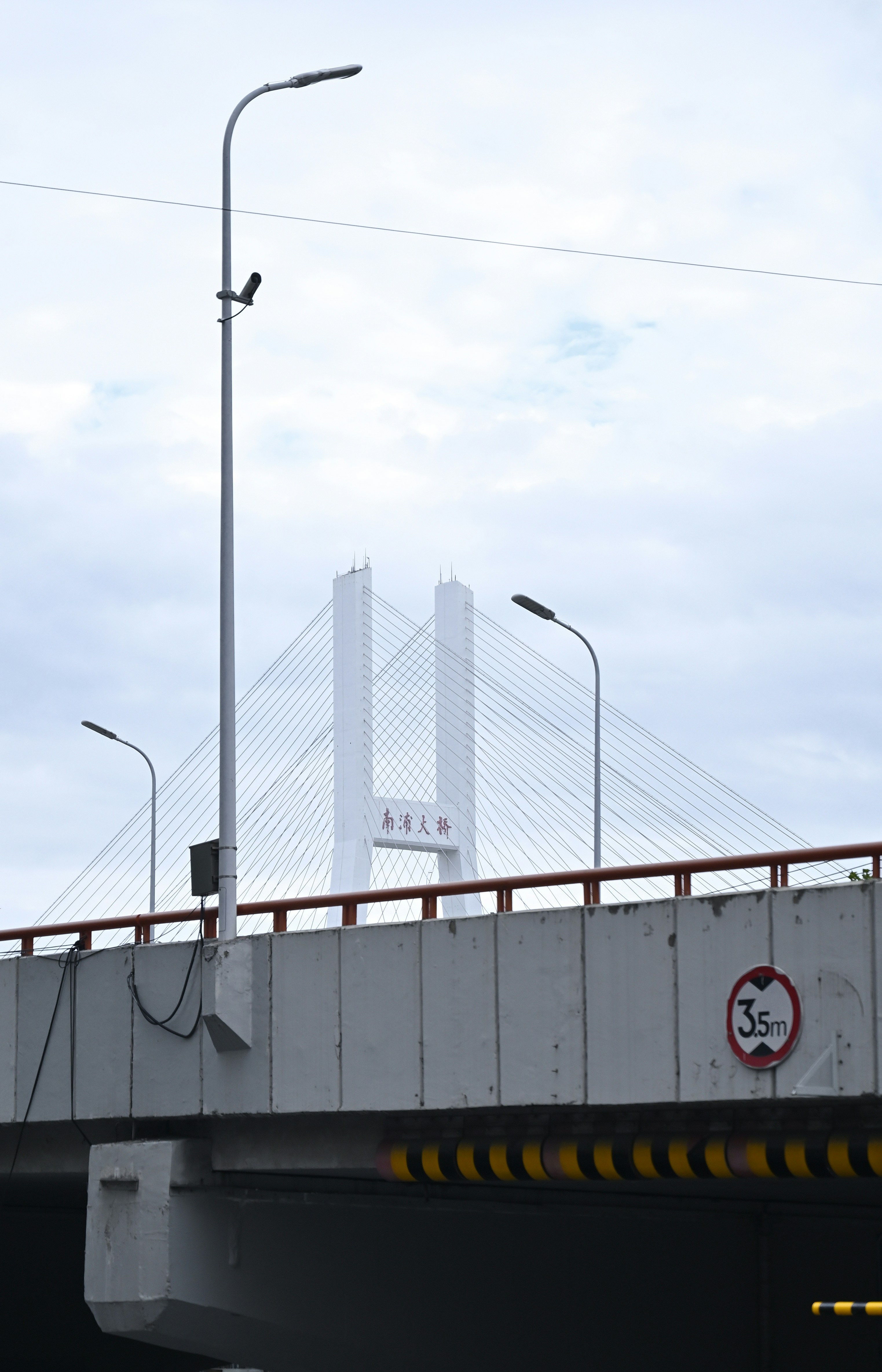 Tension in Steel: A Cable-Stayed Skyline Framed by an Urban Overpass