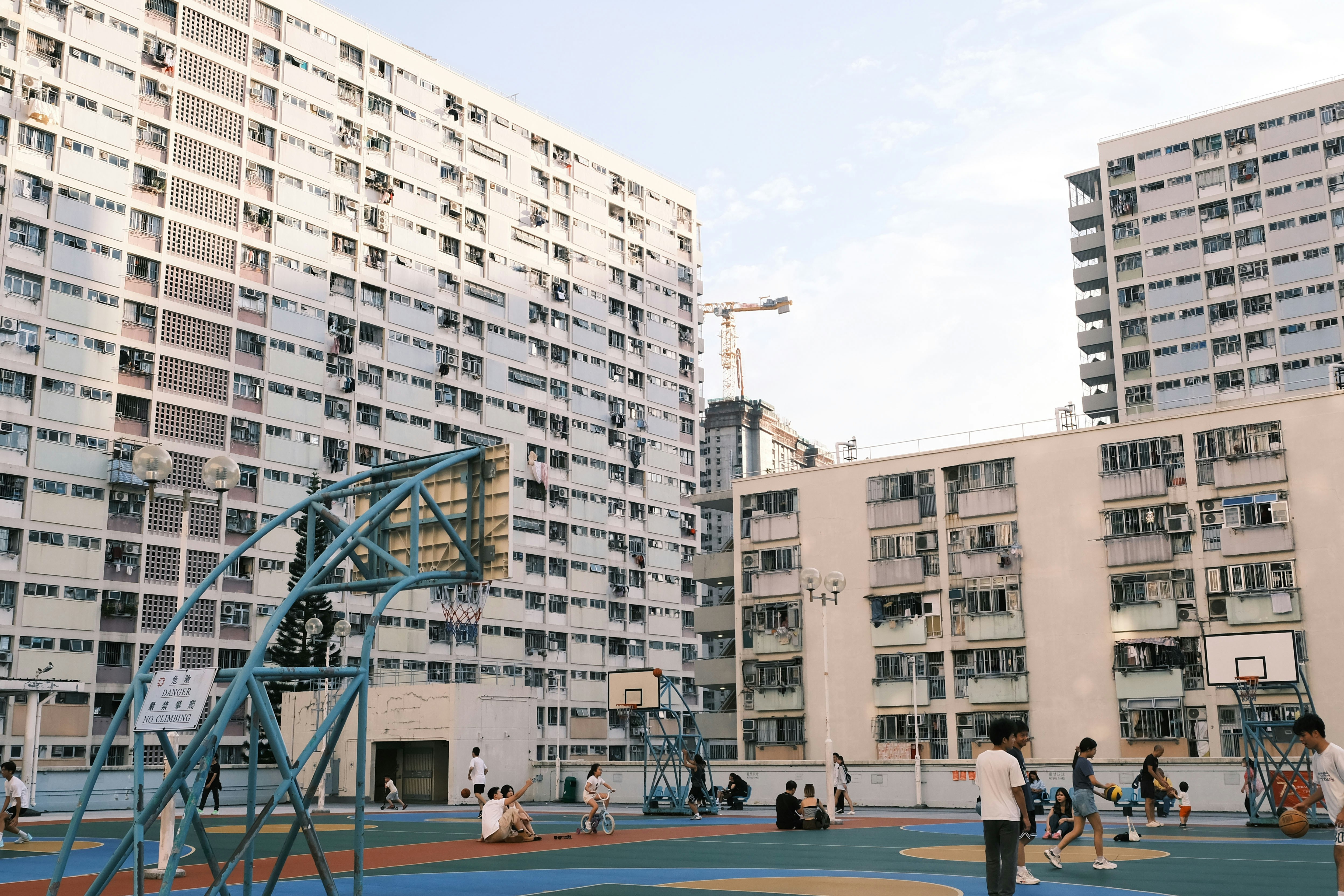 Blue Court Amid Concrete Giants: A City Playground in Daylight