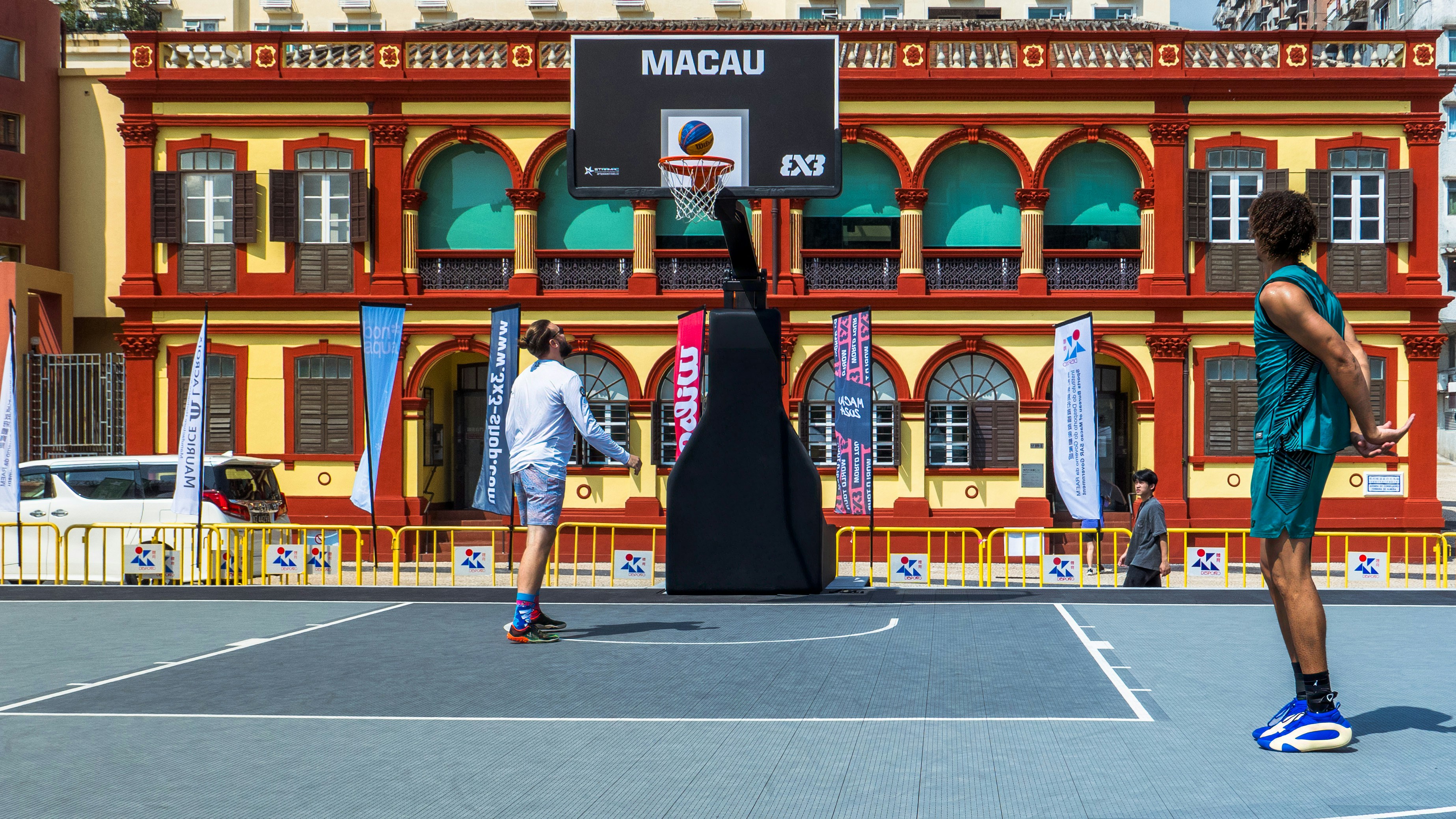 Hoop Under Macau's Arches: A Sunlit Court Scene