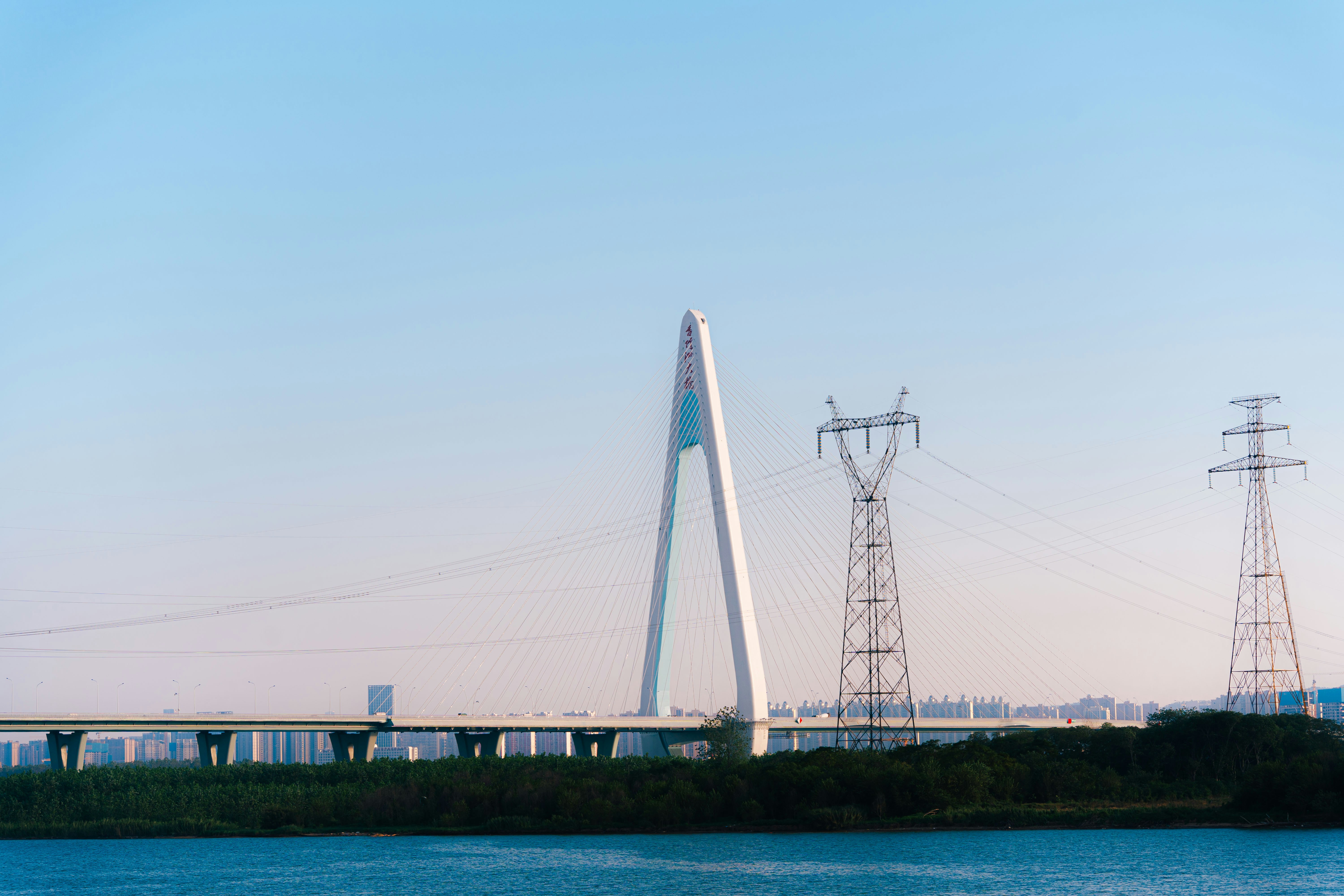 A body of water with power lines in the background photo – Free Tower ...