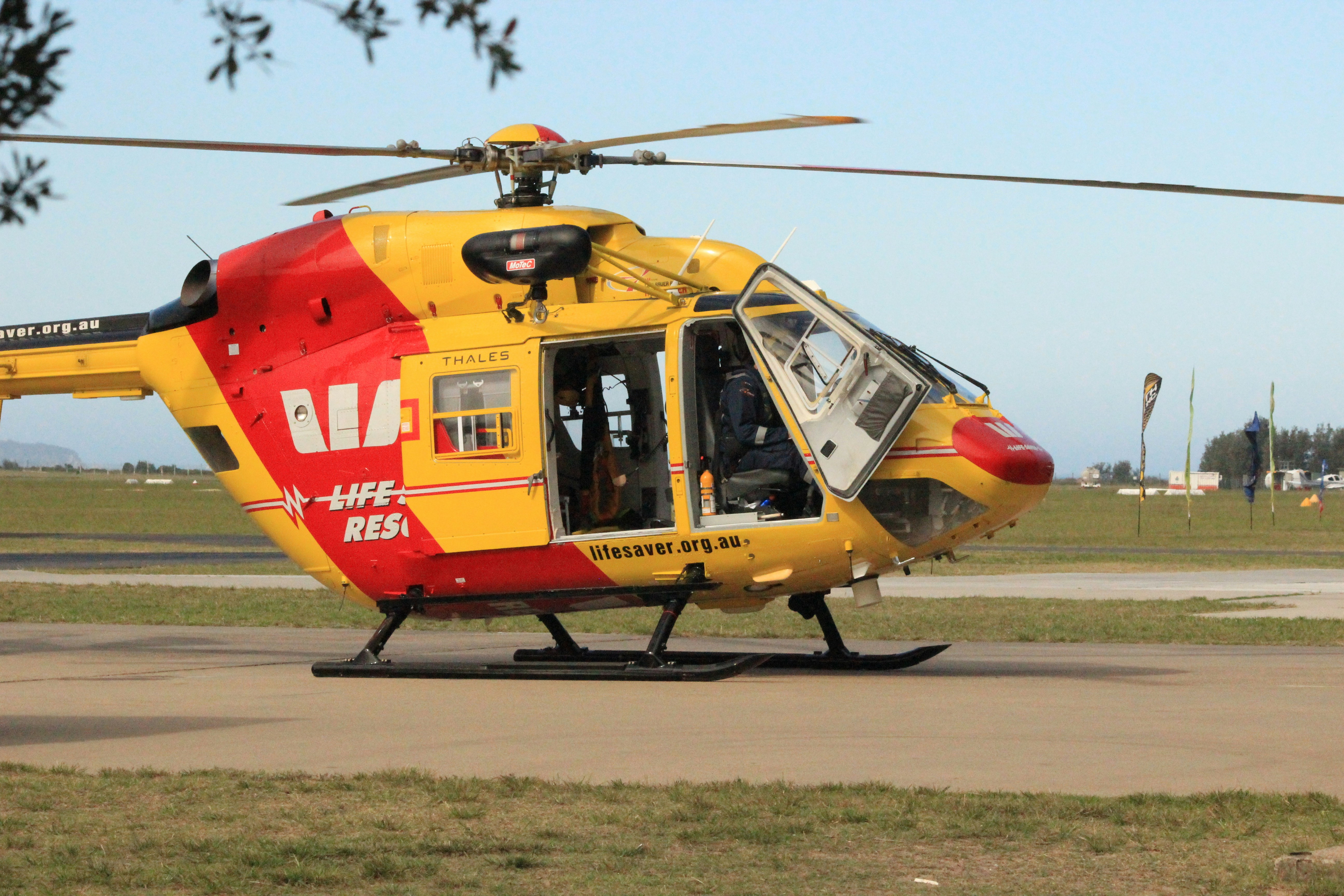 A red and yellow helicopter on a runway photo – Free Moruya nsw Image ...