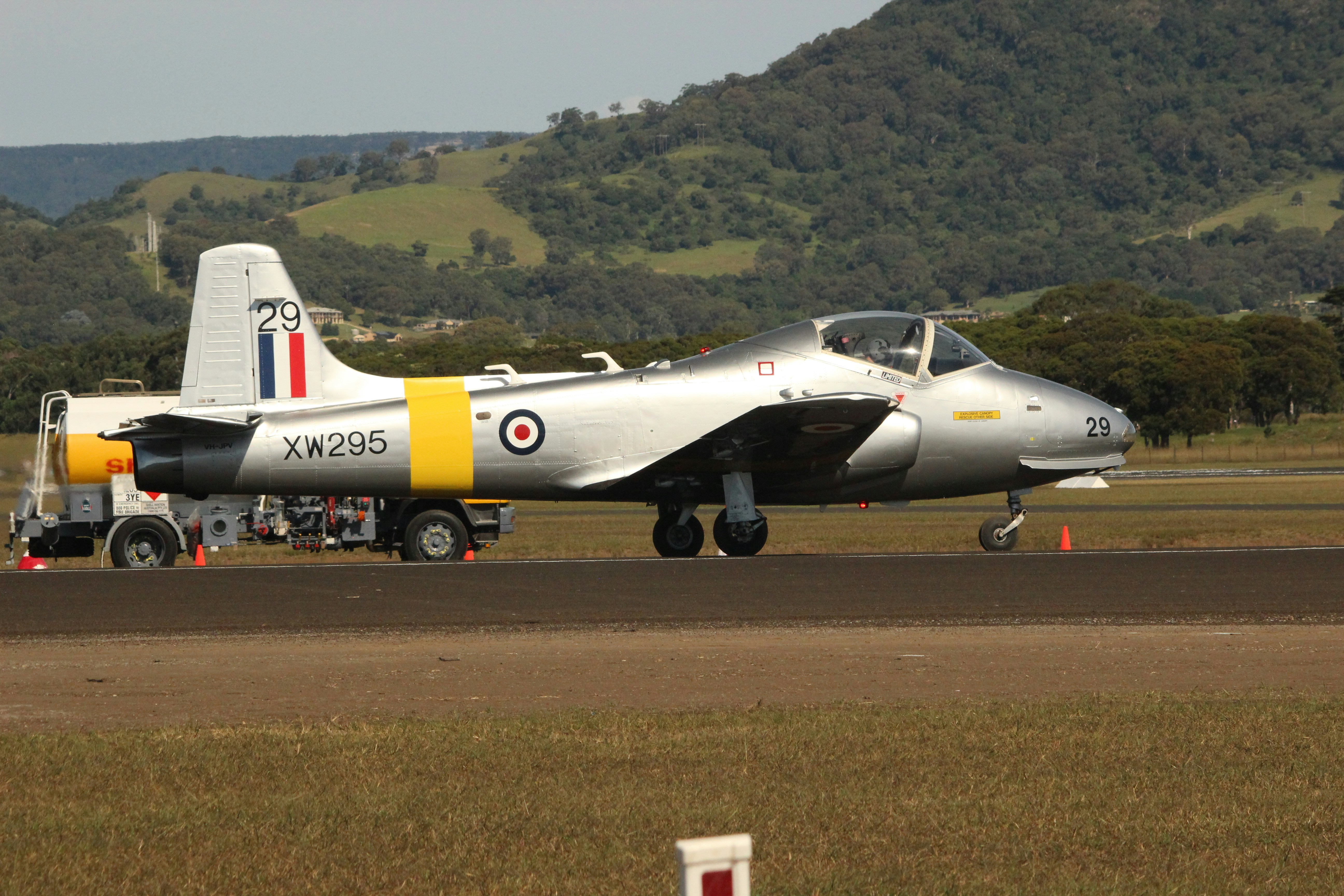 Historic Silver Jet Resting on a Rural Runway