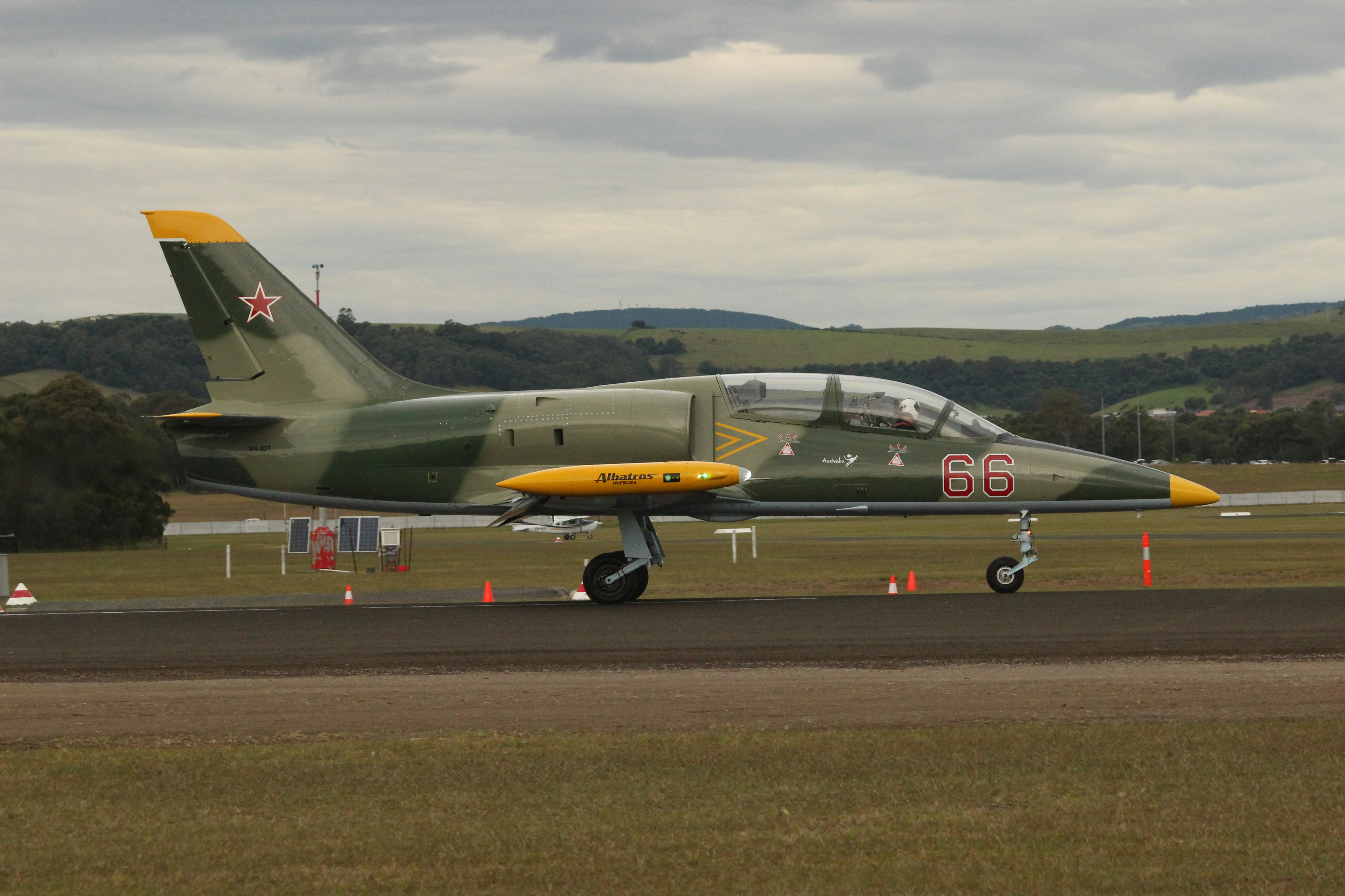 A green and yellow plane is on a runway photo – Free Shellharbour nsw ...