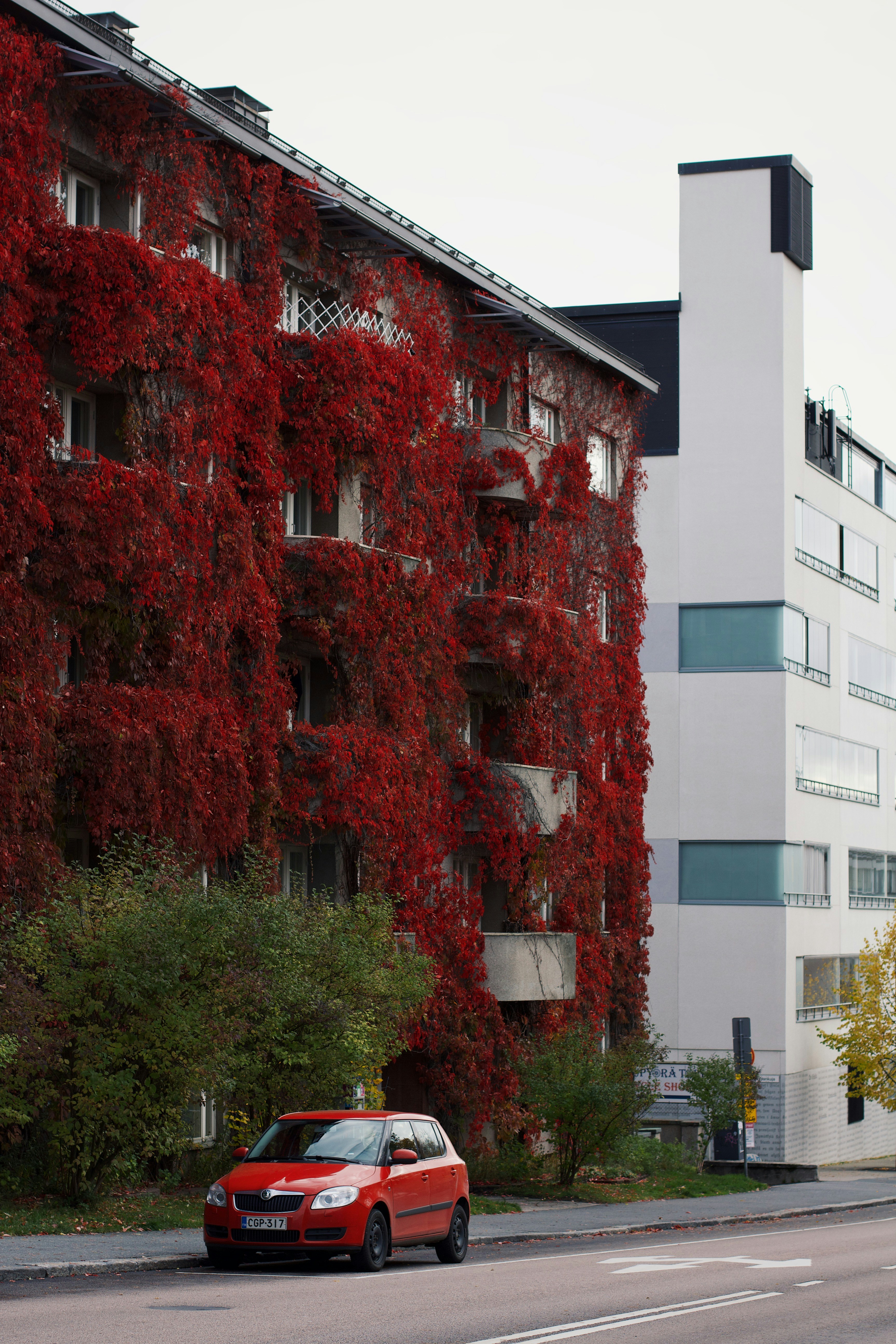Crimson Cling: A Red Facade with a Hidden Street Level Car