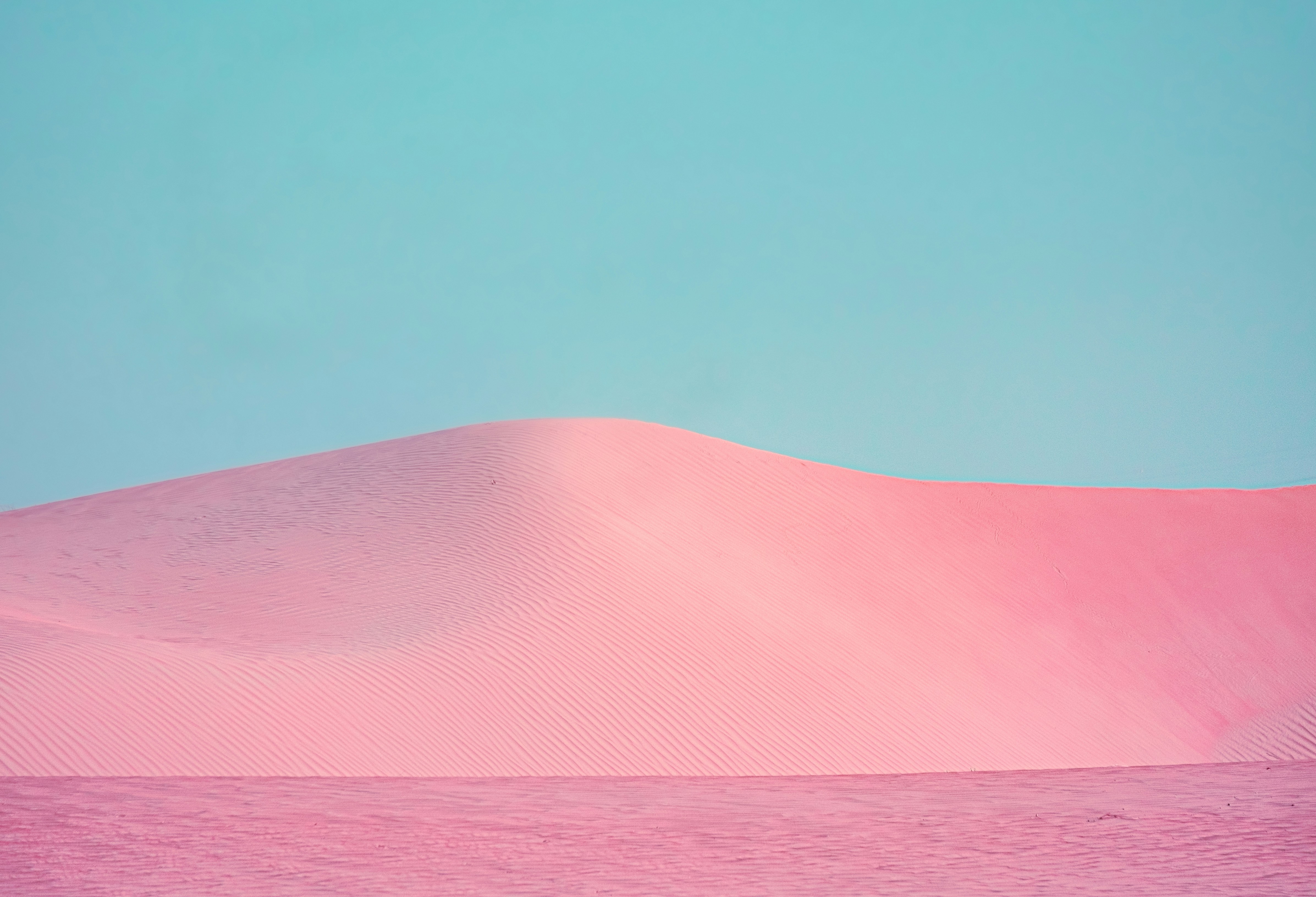 A pink hill with a blue sky in the background photo – Free Nature Image ...