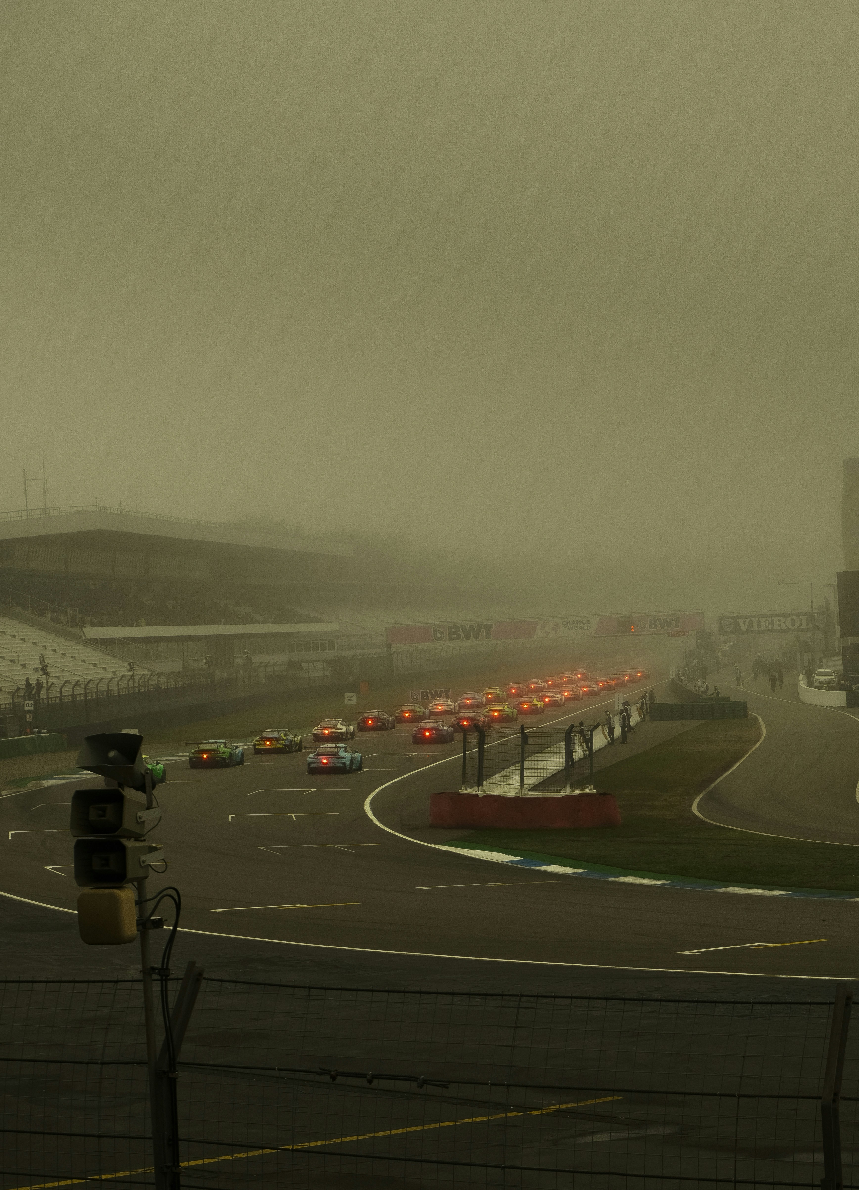 Haze over the Circuit: A Red-Taillight Train on the Curved Track