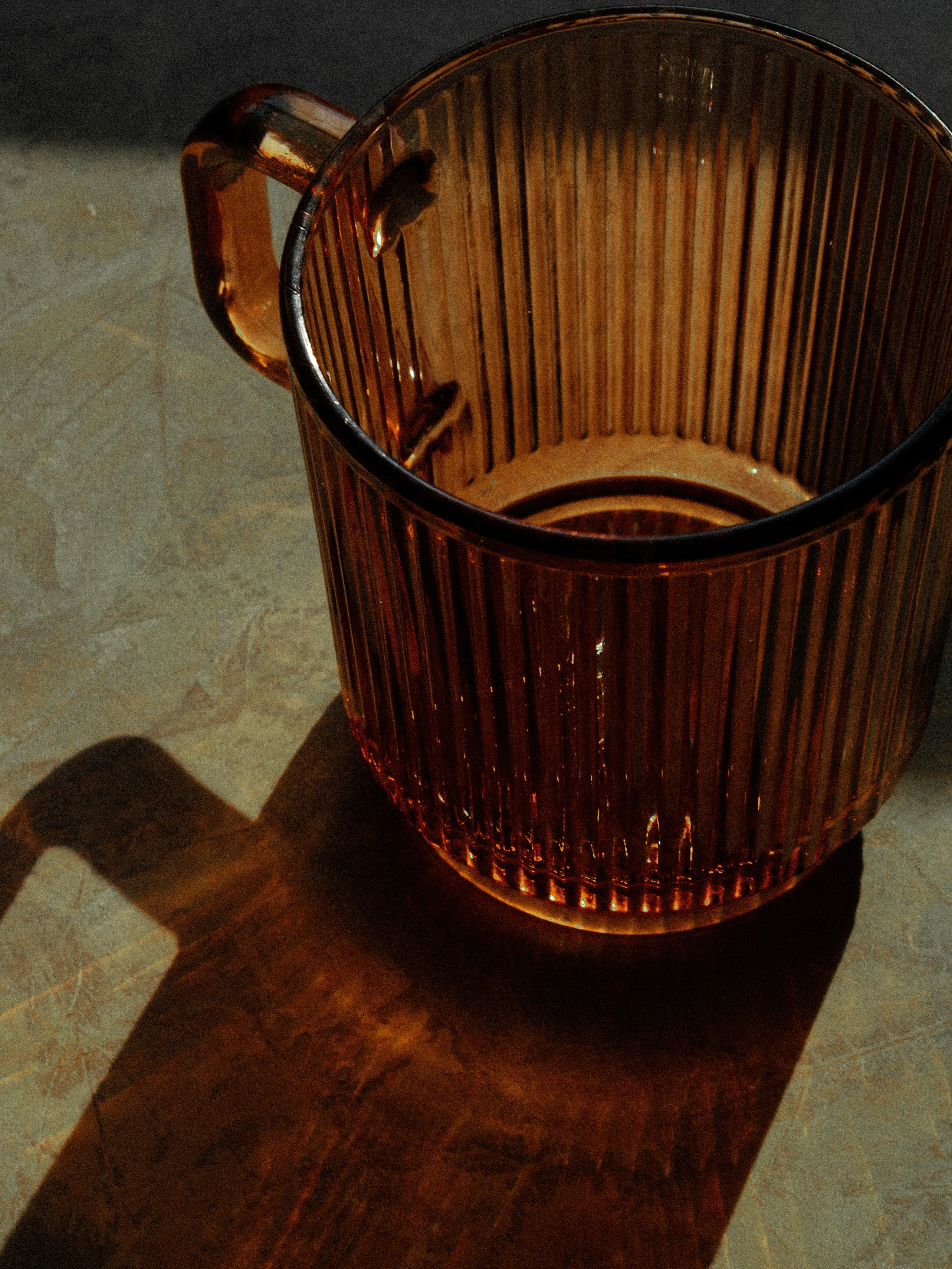 Amber Ribbed Mug in Warm Light Casts a Quiet Shadow