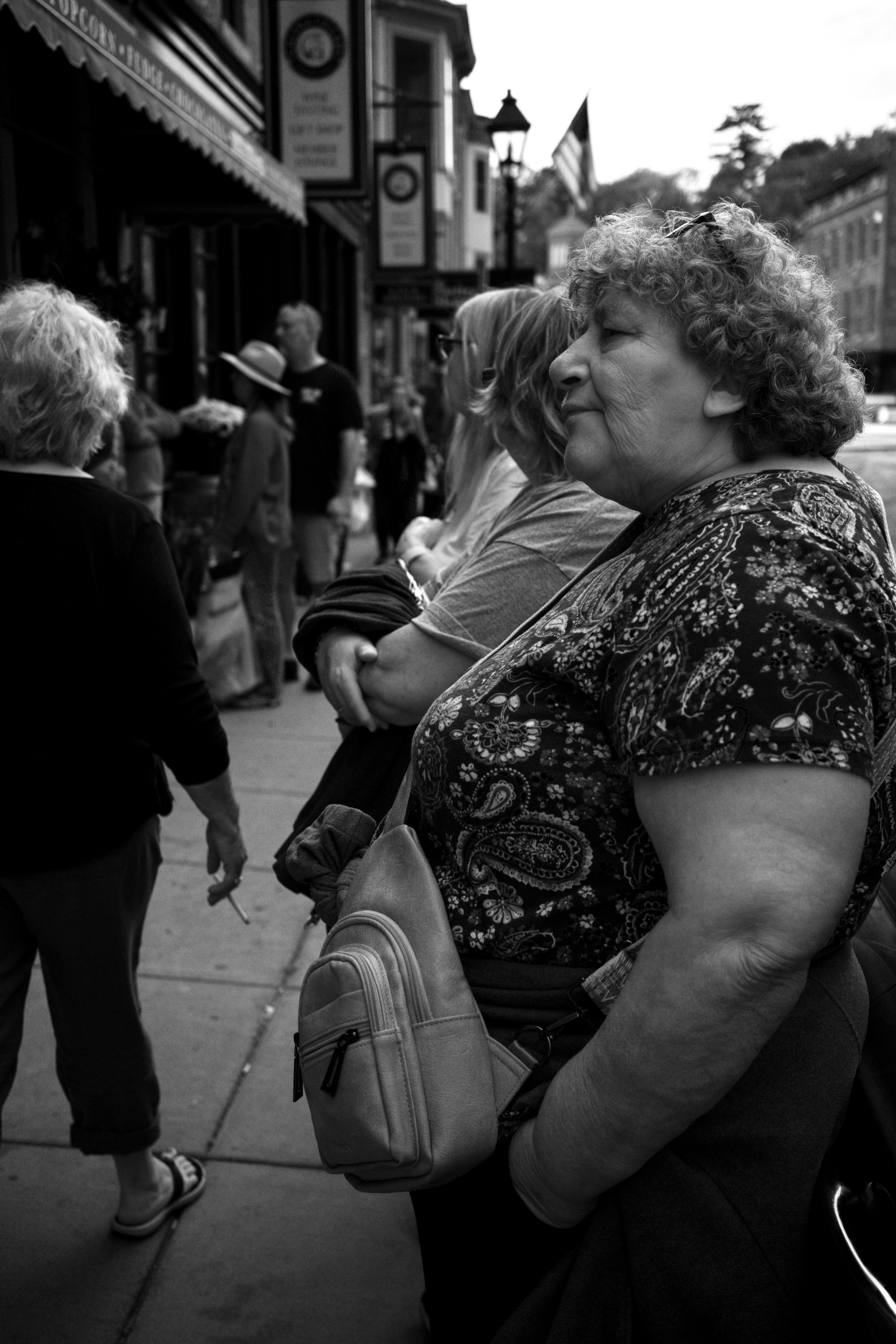 Crossroads of Curiosity: A Side Portrait in a Busy Street