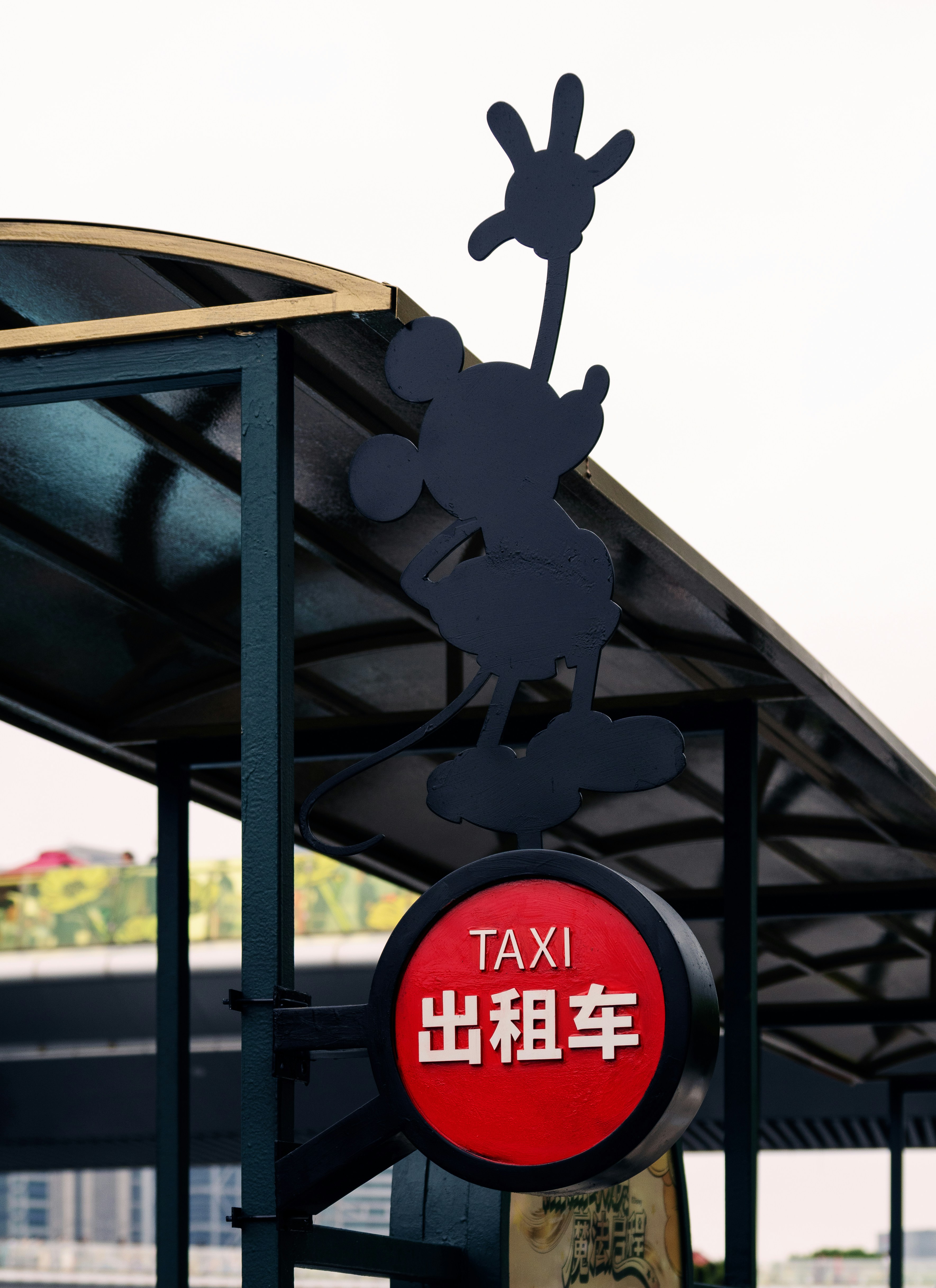 Red Taxi Emblem Beneath a Silhouette Overhead