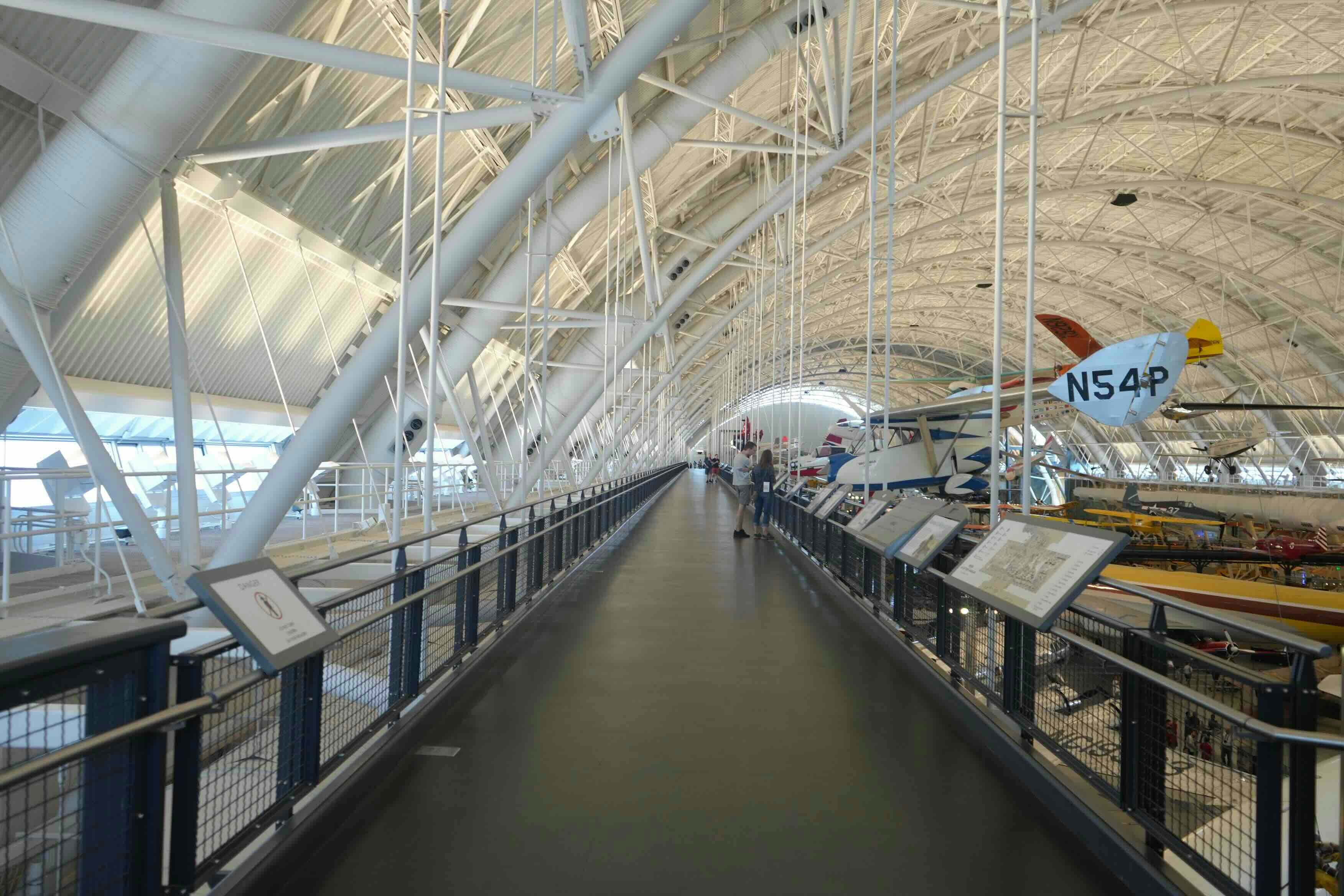 A walkway inside of a large building with lots of windows photo – Free ...