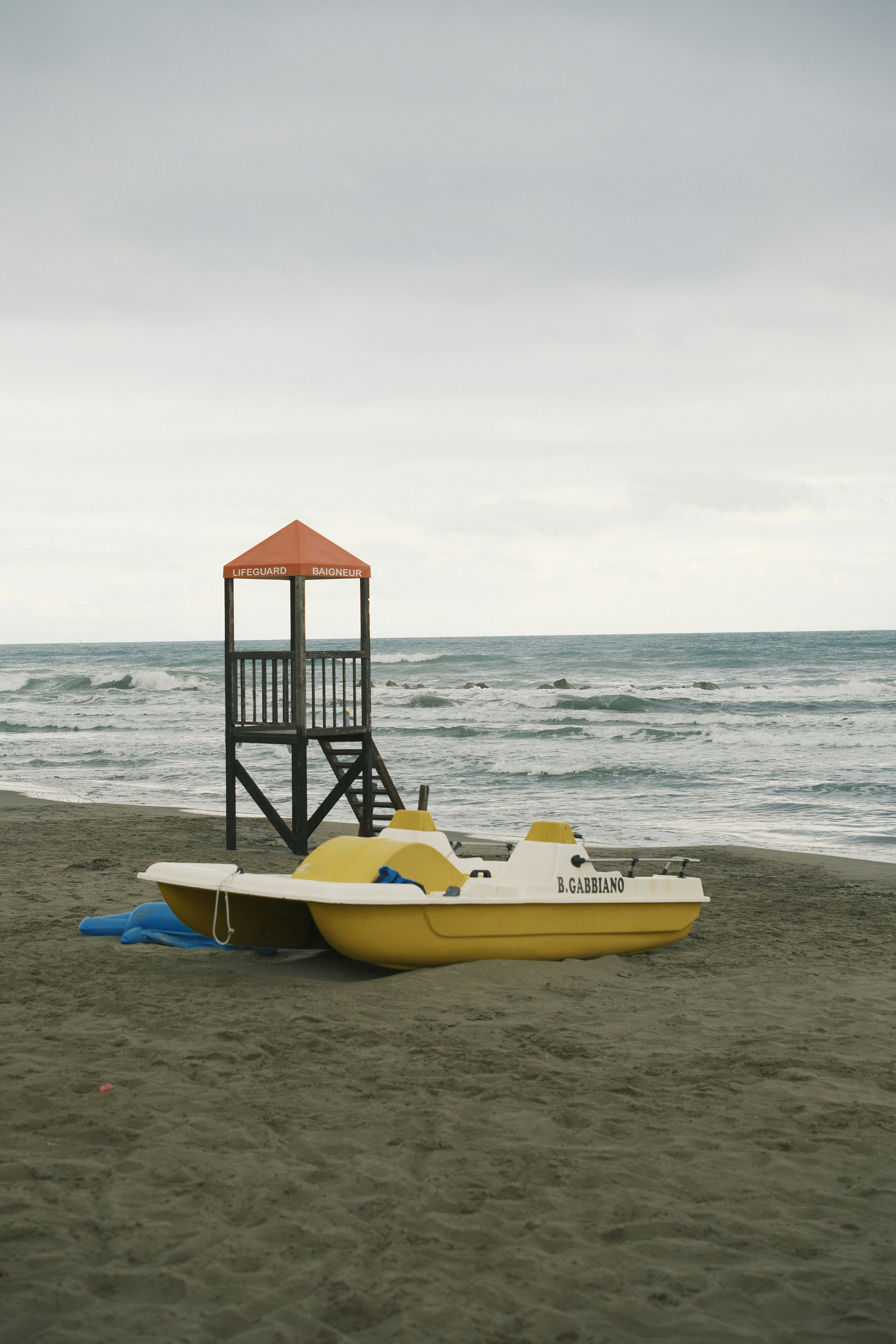 Yellow Pedal Boat at Quiet Beach: Lifeguard Tower in a Calm Seascape
