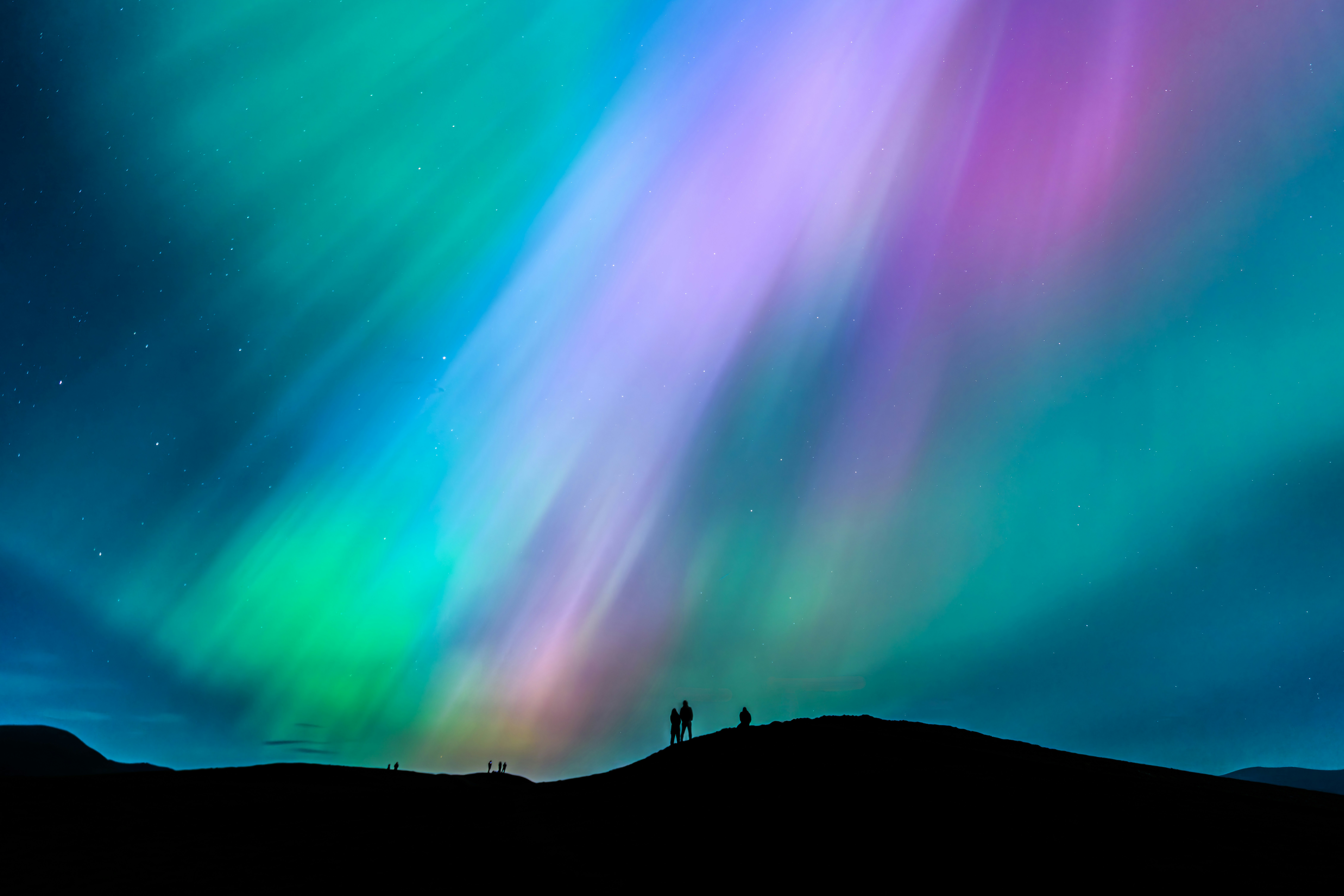 Aurora Silhouettes: Night Sky Dances Over a Lone Hill