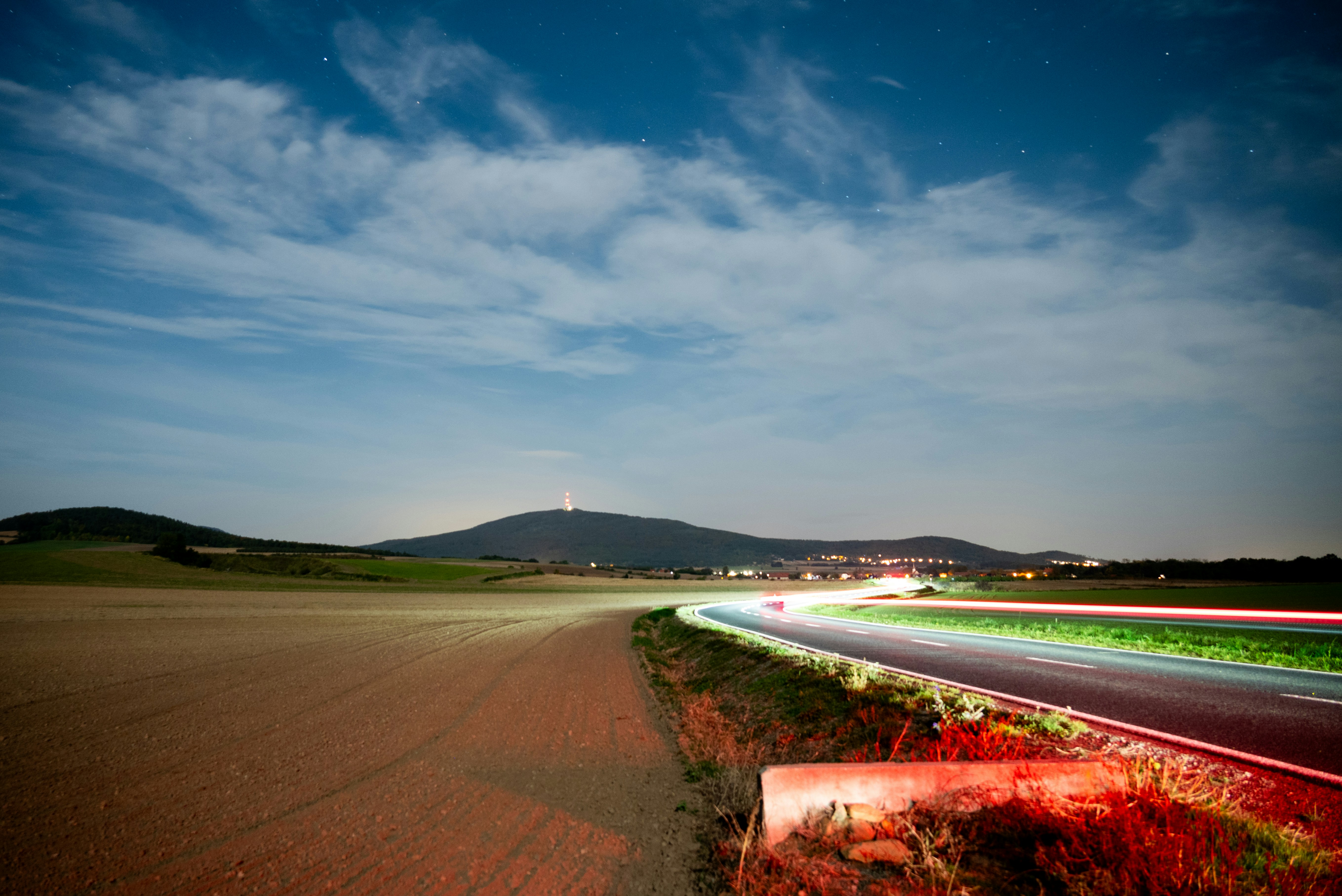 Horizon Beacon over a Winding Road: Hilltop Tower at Dusk