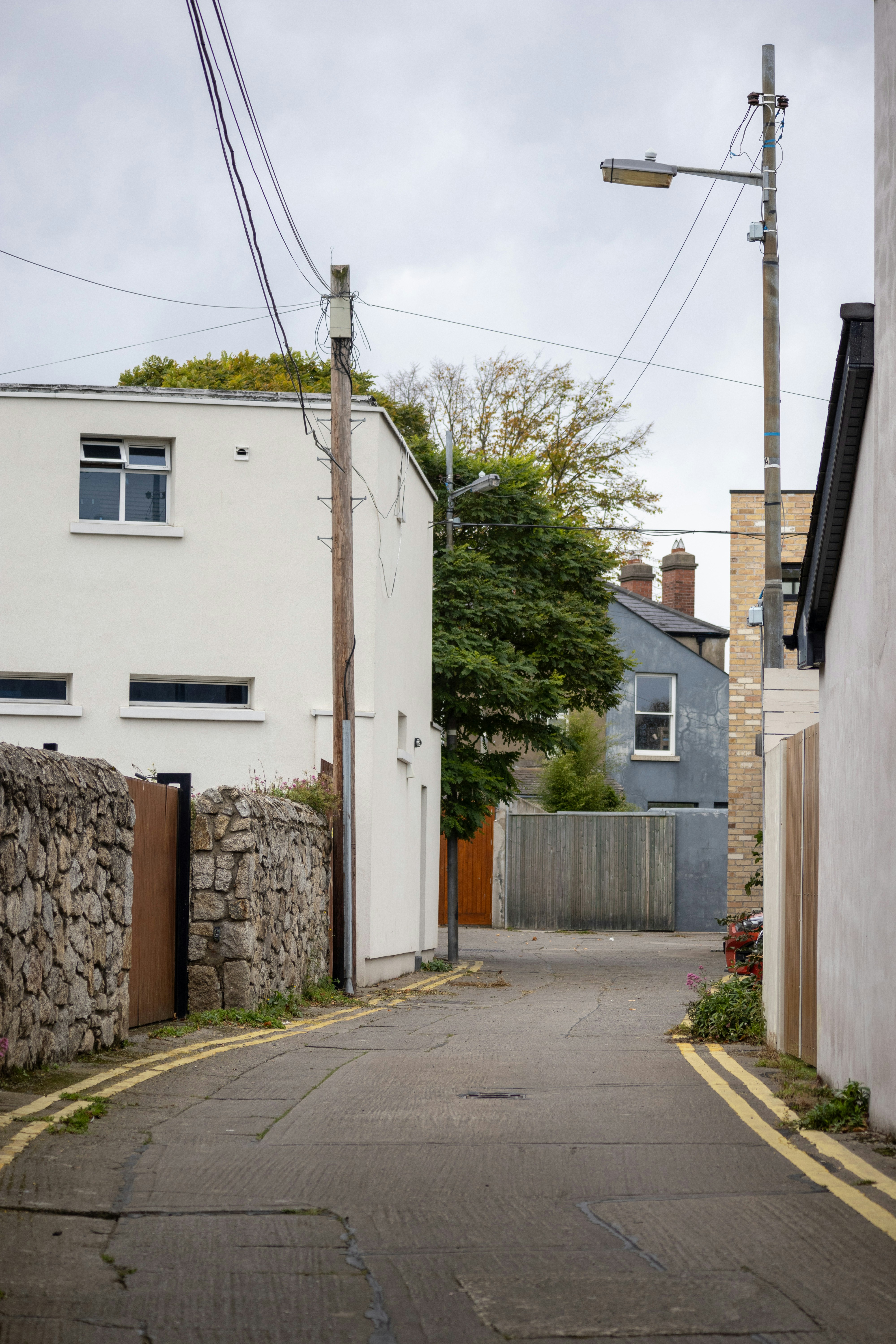 Alley Convergence: A Quiet Urban Corridor Toward a Distant Gate
