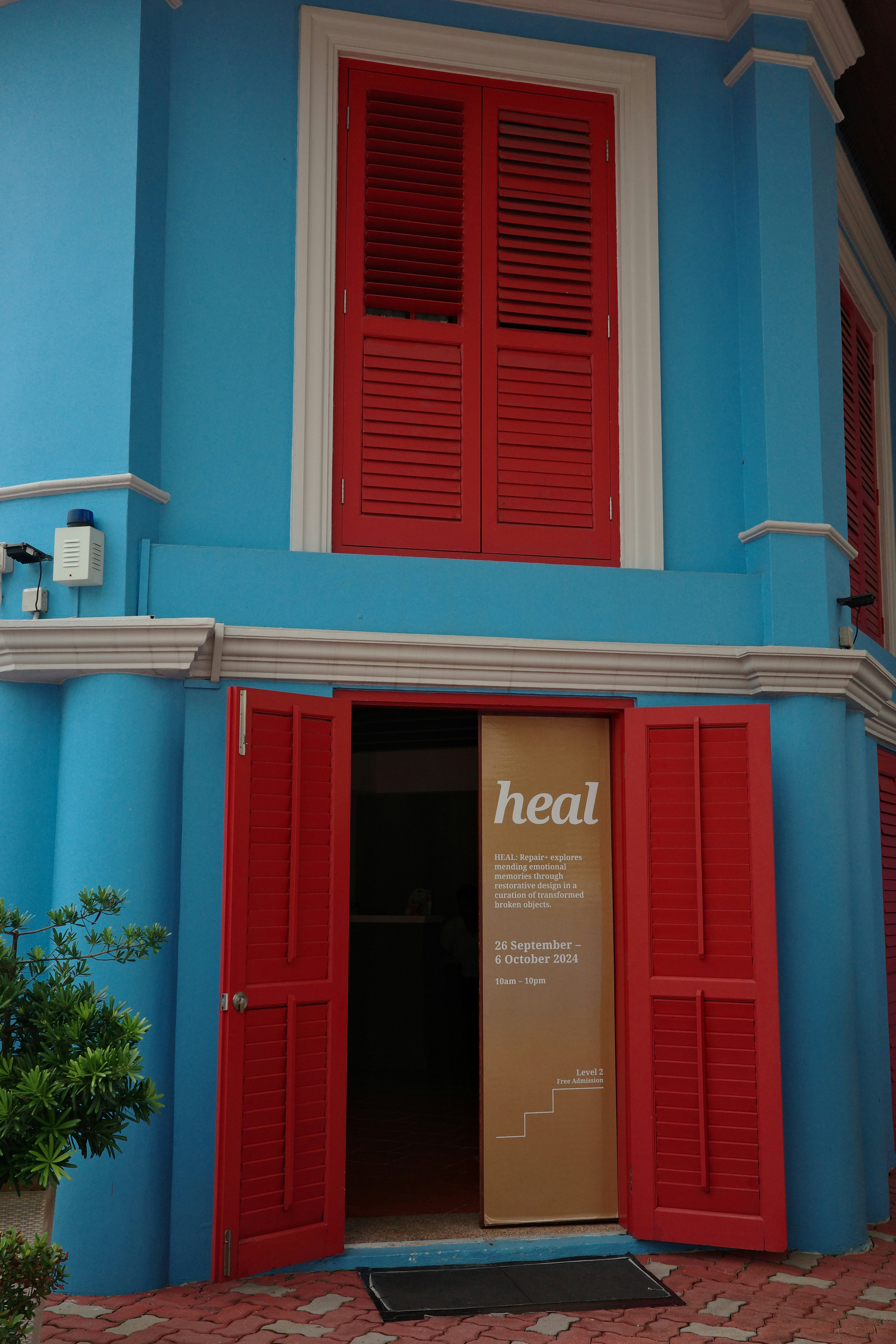Azure Facade with Ruby Shutters: An Open Door to Heal