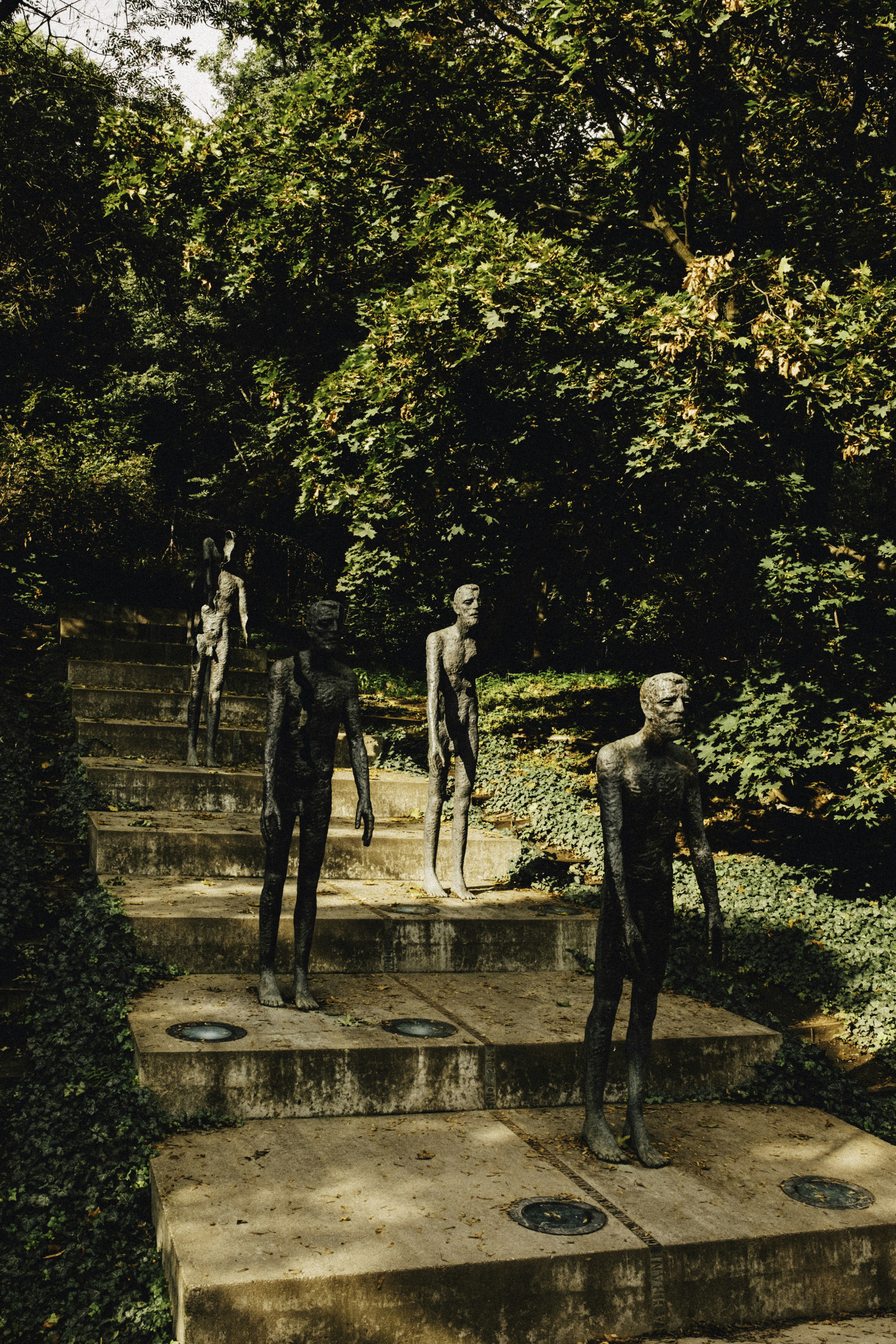 Quiet Parade on the Garden Steps: Bronze Figures in Autumn Light