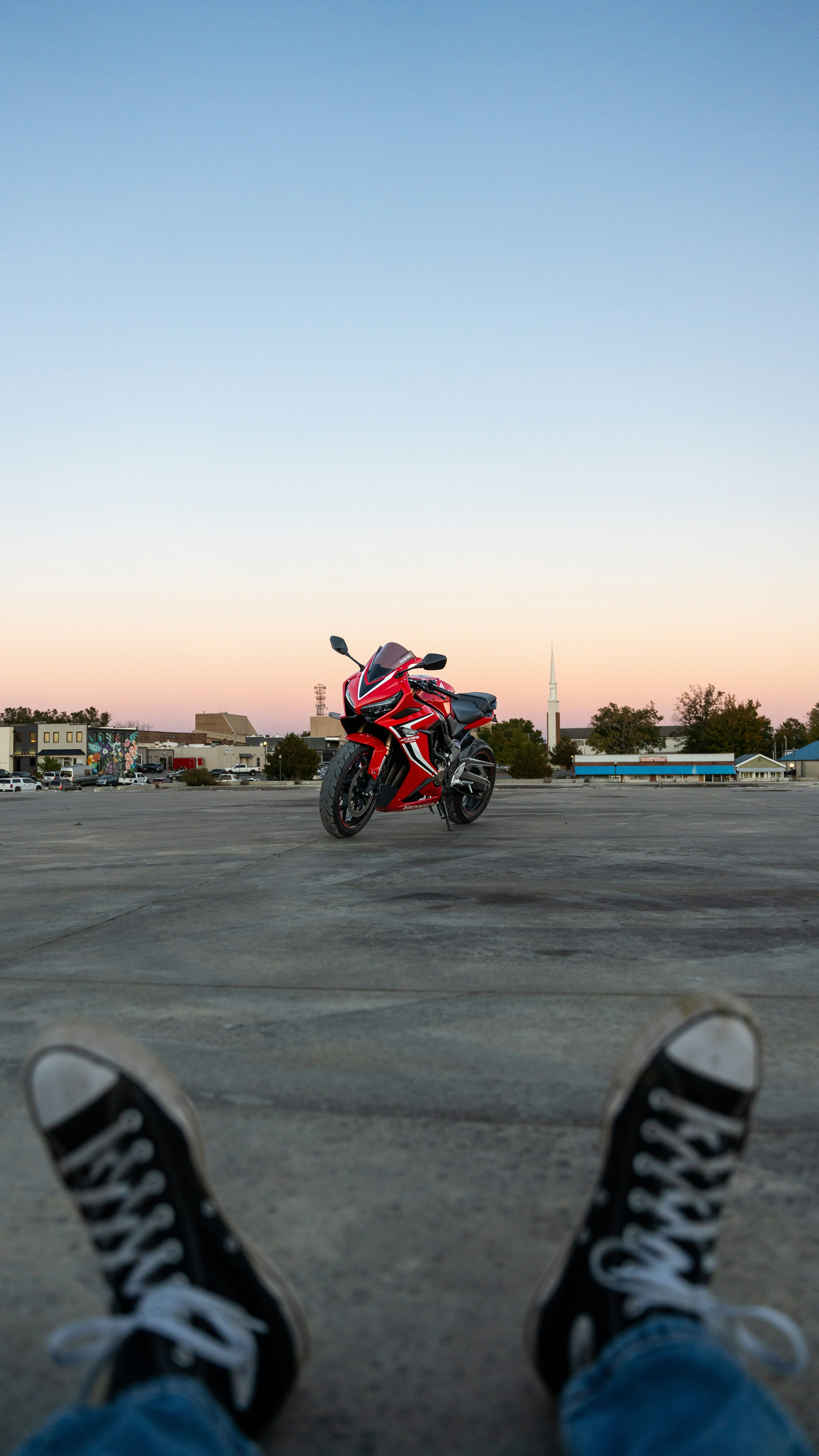 Red Sportbike in a Quiet Parking Lot at Sunset