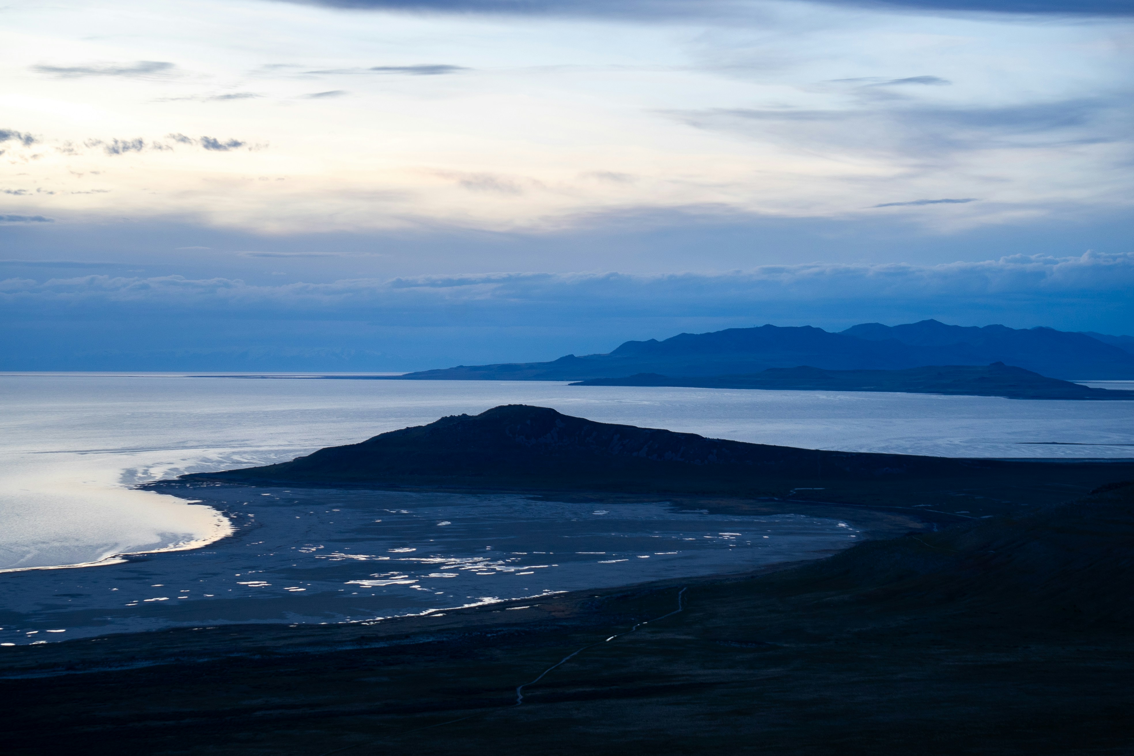 A large body of water sitting under a cloudy sky