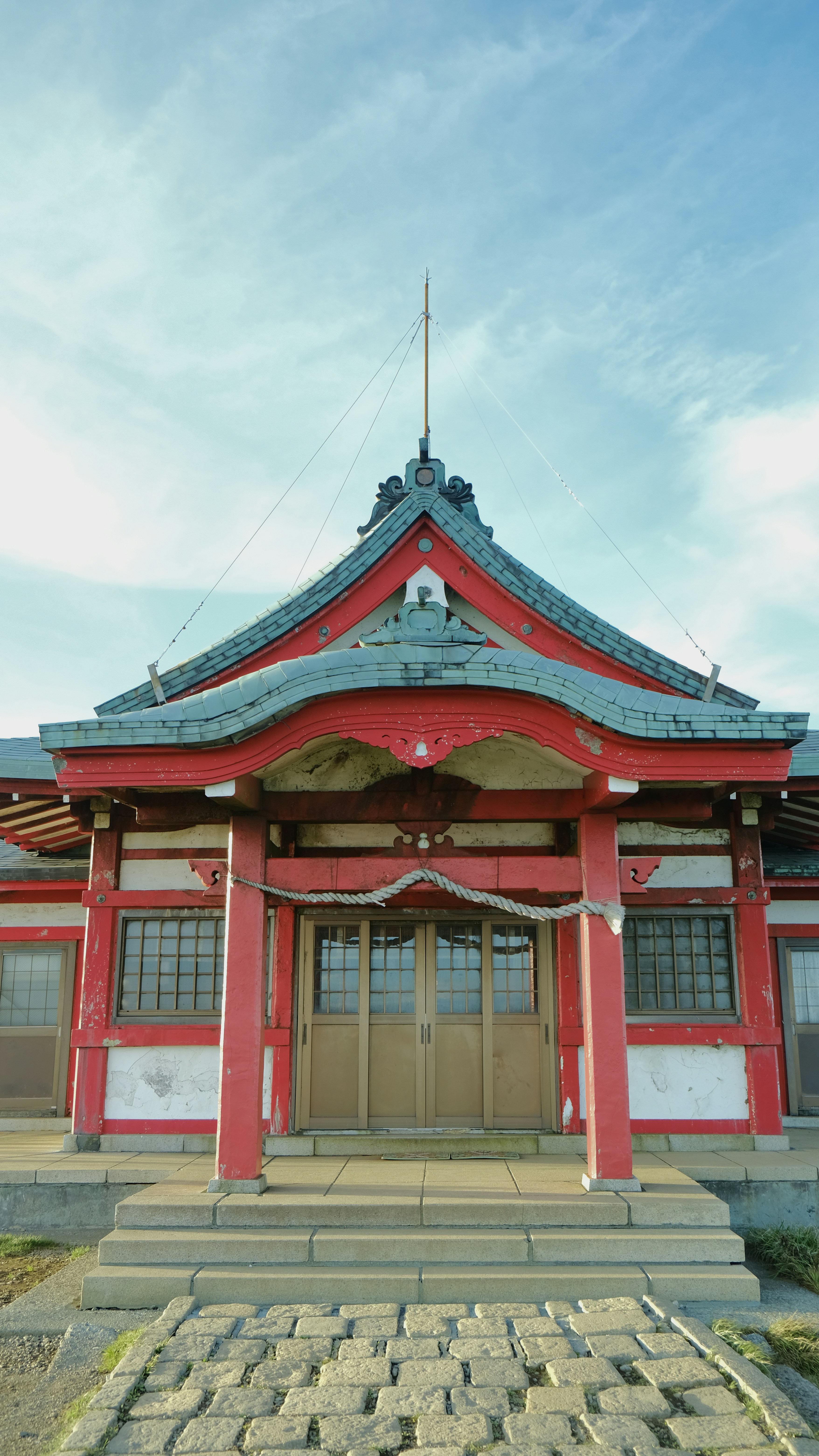 Crimson Shrine Under a Turquoise Roof Crest
