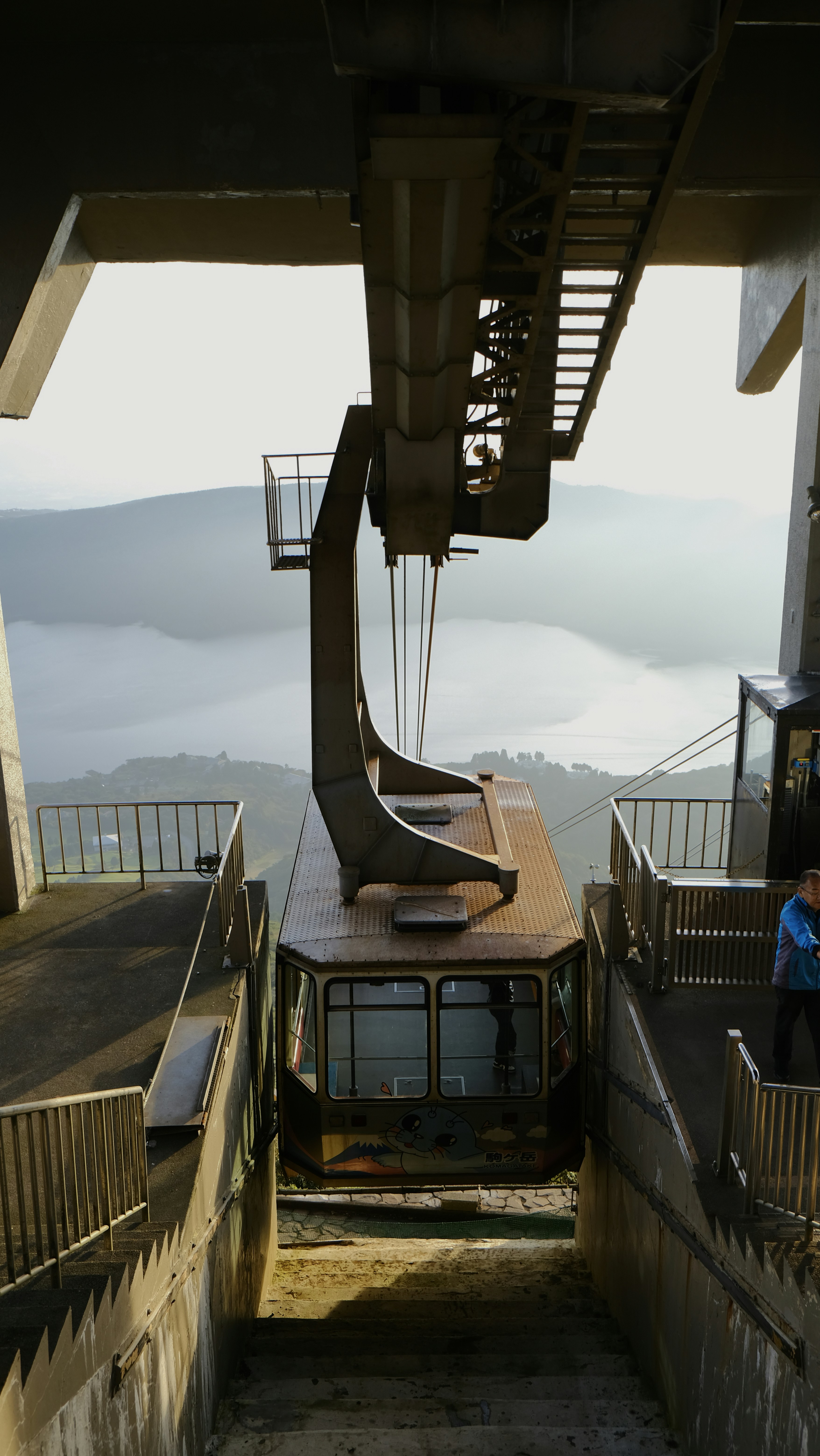 Cable Car at the Summit: Steel Spine Reaches Through Morning Fog