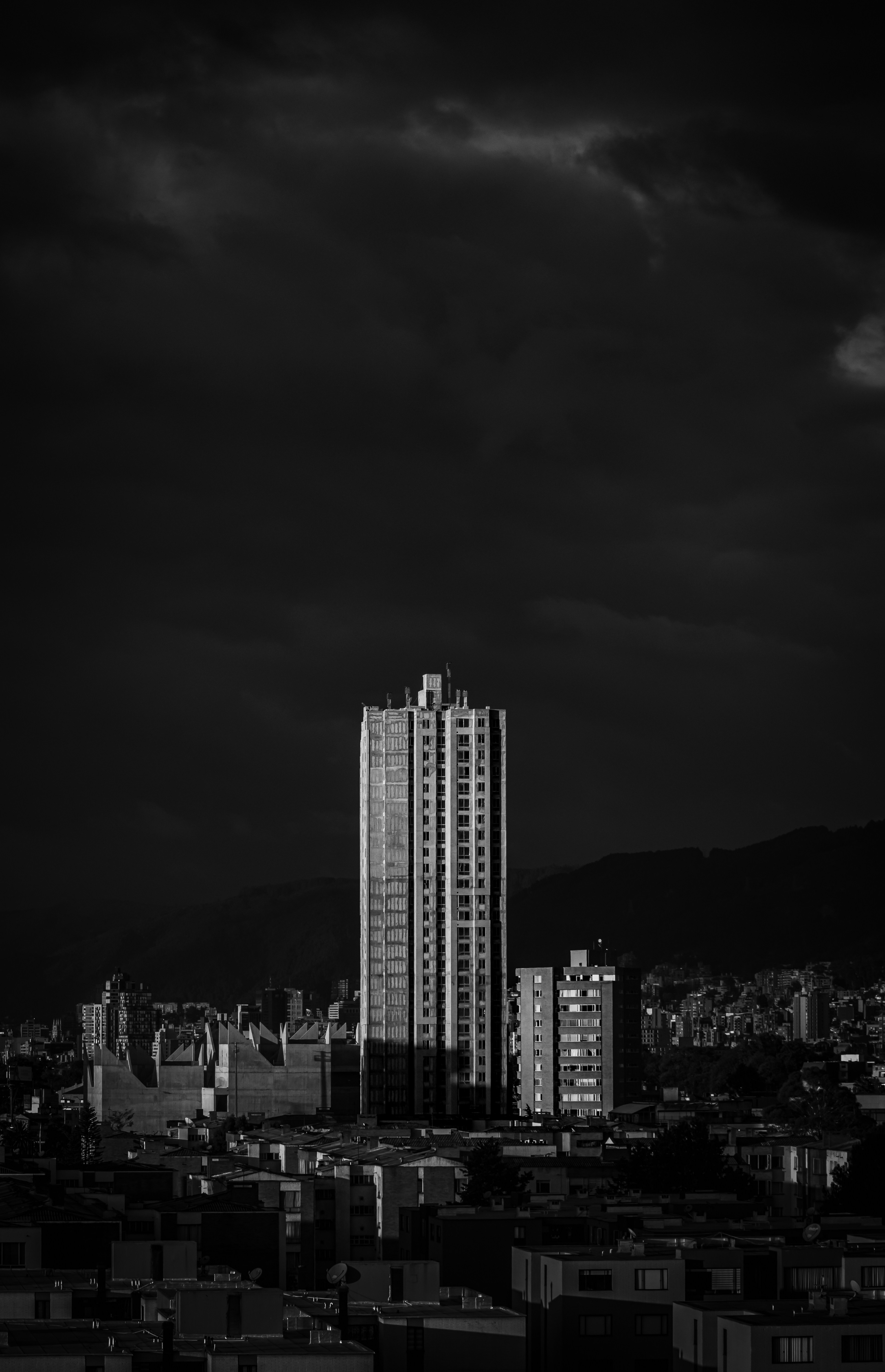 Midnight Sentinel: A lone high-rise rises above a storm-dark skyline