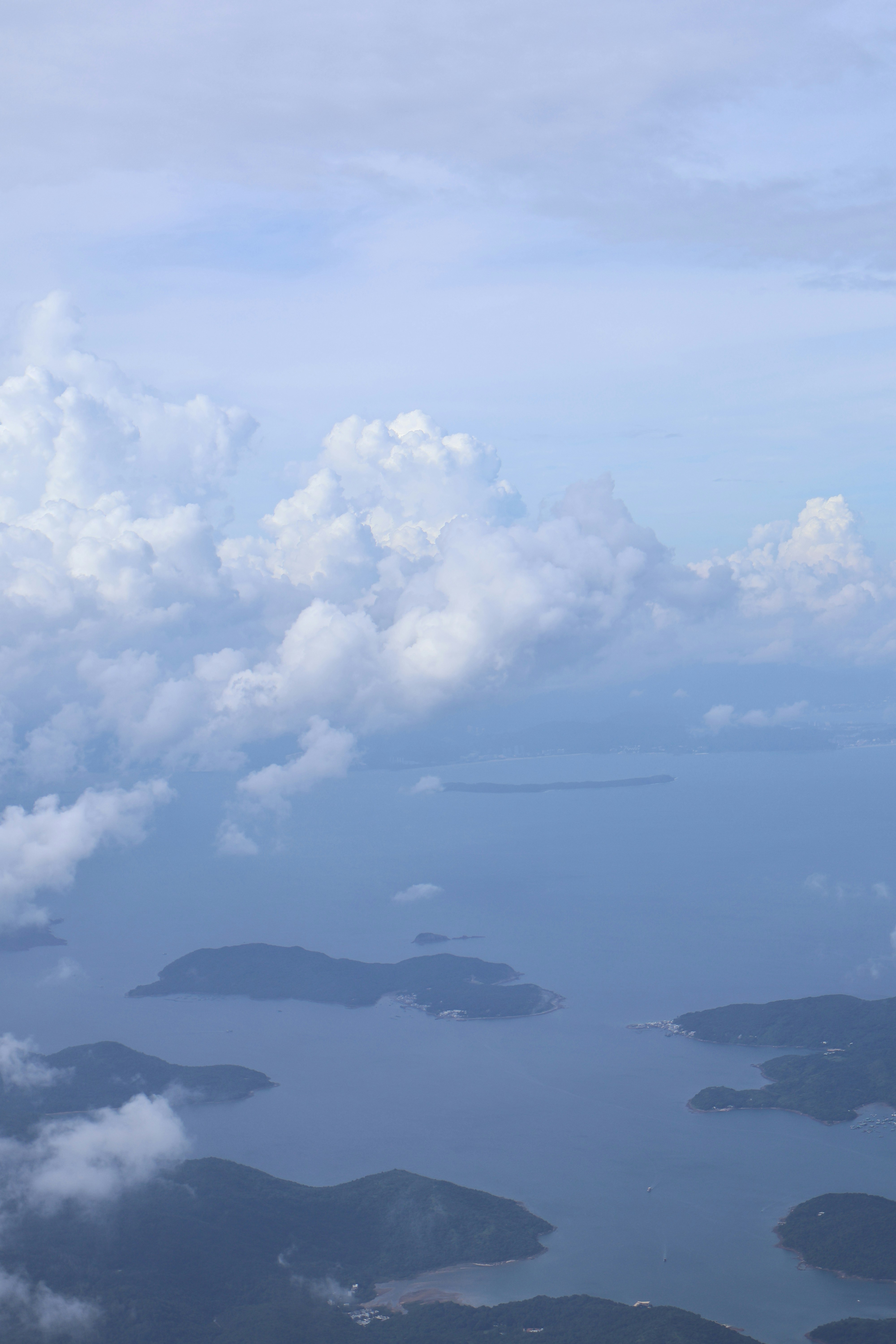 Azure Archipelago: Distant Islands under Cloud-Dusted Sky