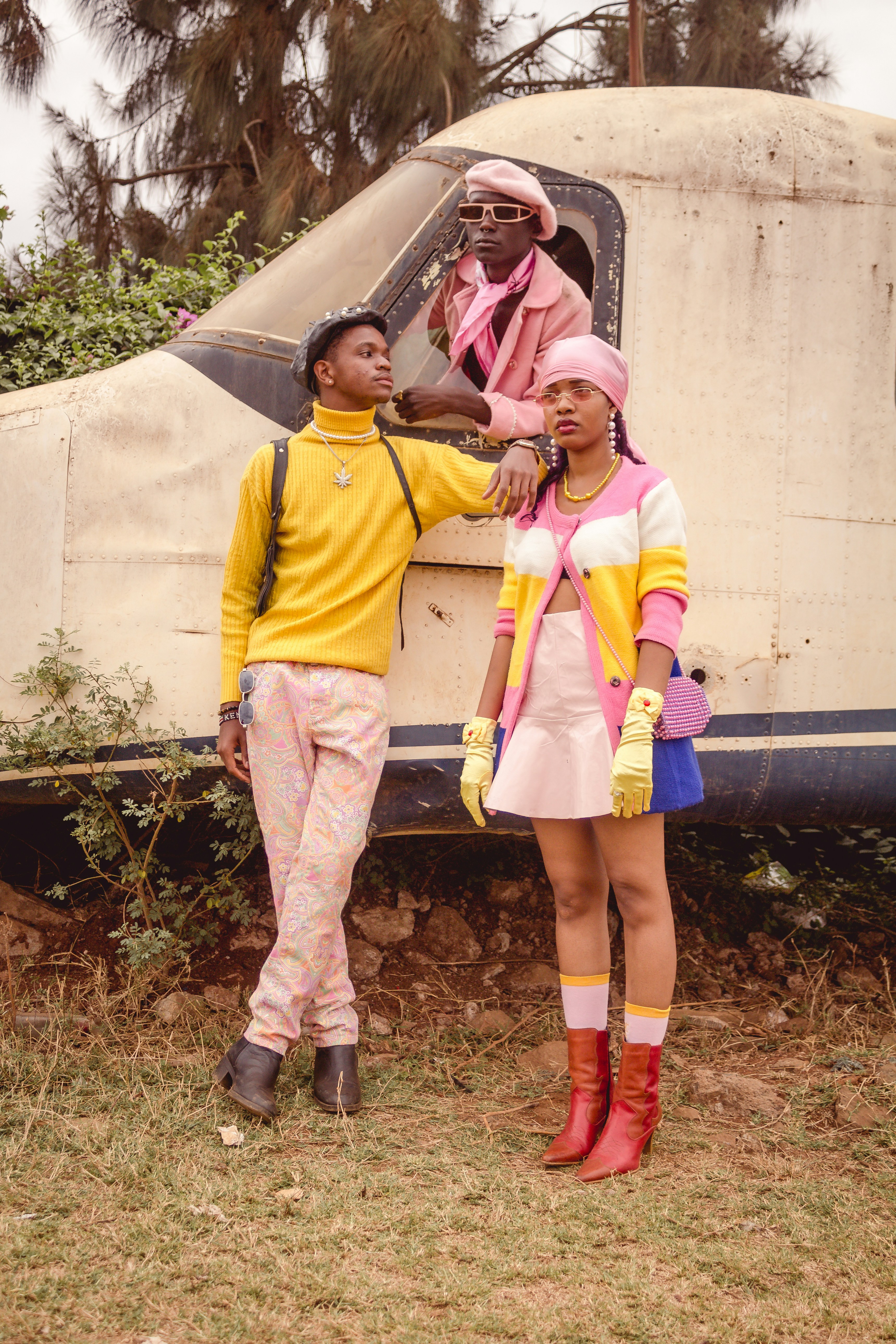 Pastel Power Trio: Neon Retro Fashion Beside a Weathered Aircraft