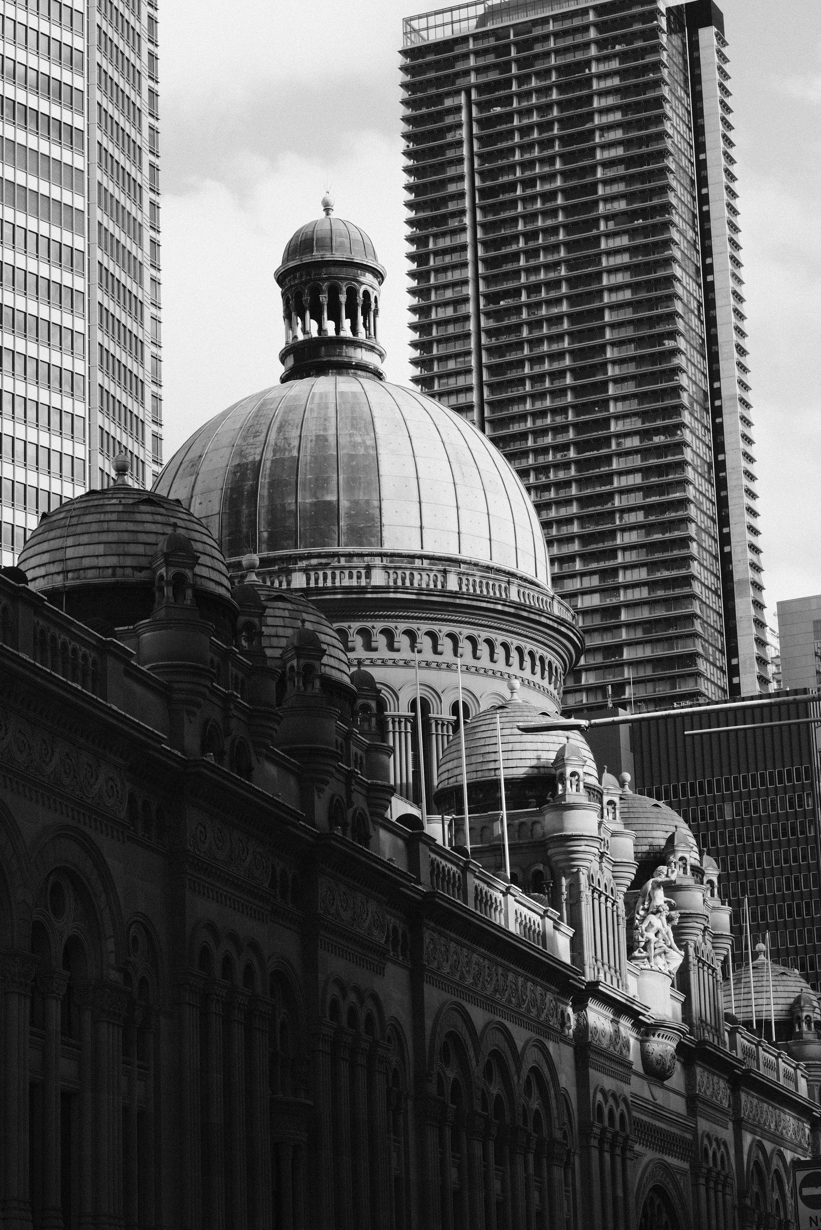 A black and white photo of a building with a dome