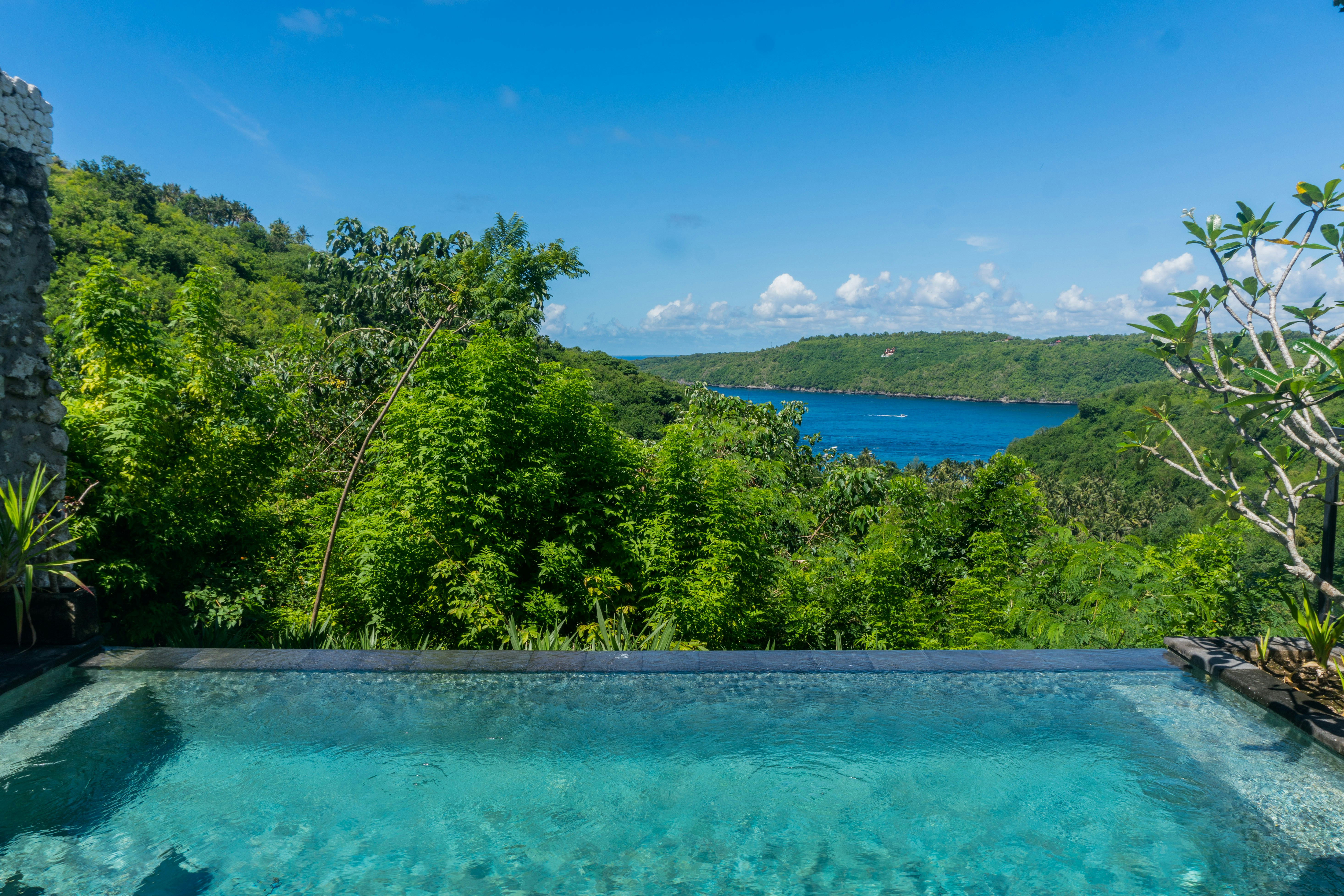 A swimming pool with a view of a lake photo – Free Infinity pool Image ...