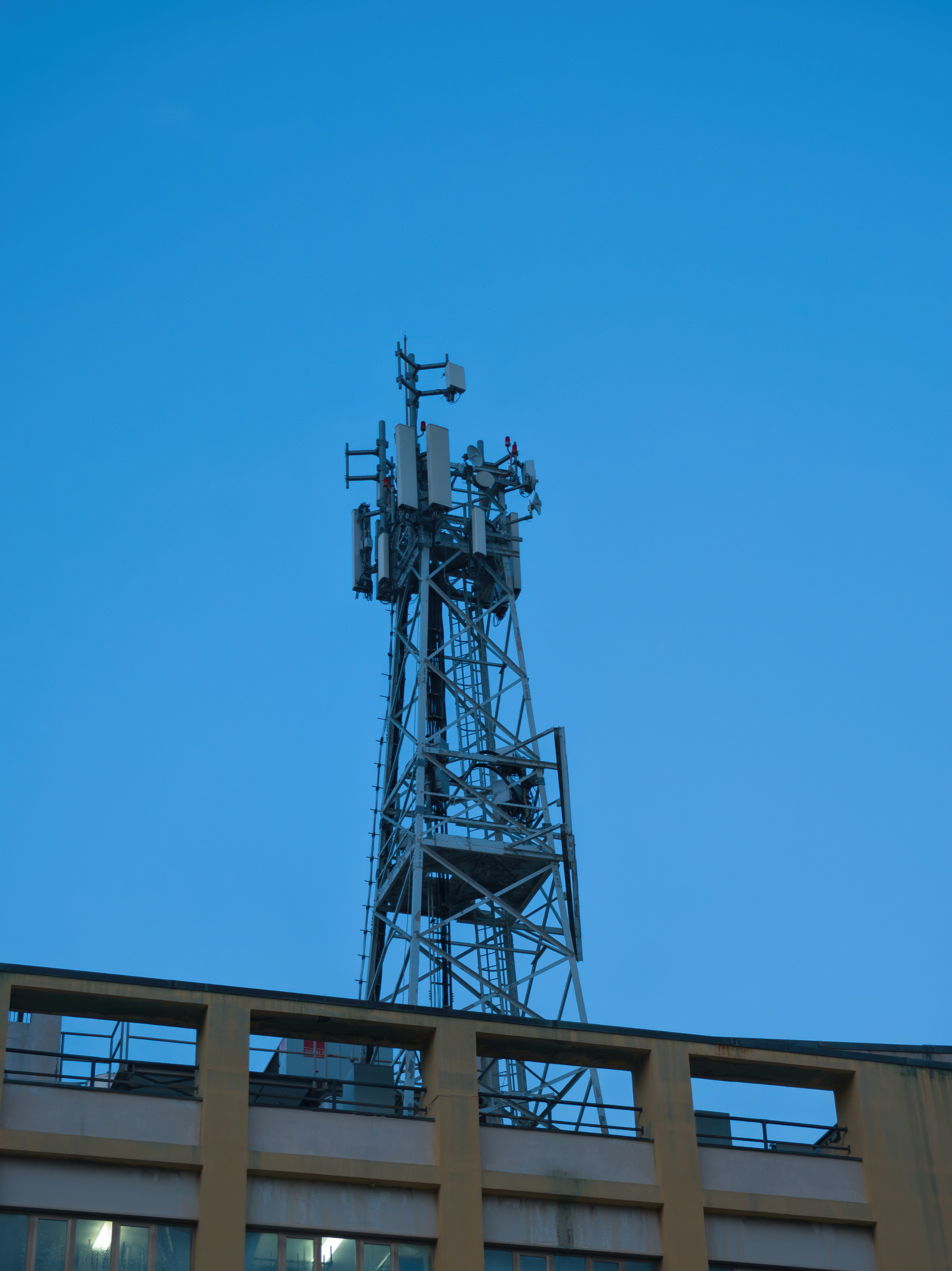 A tall tower with a cell phone on top of it photo – Free Building Image ...