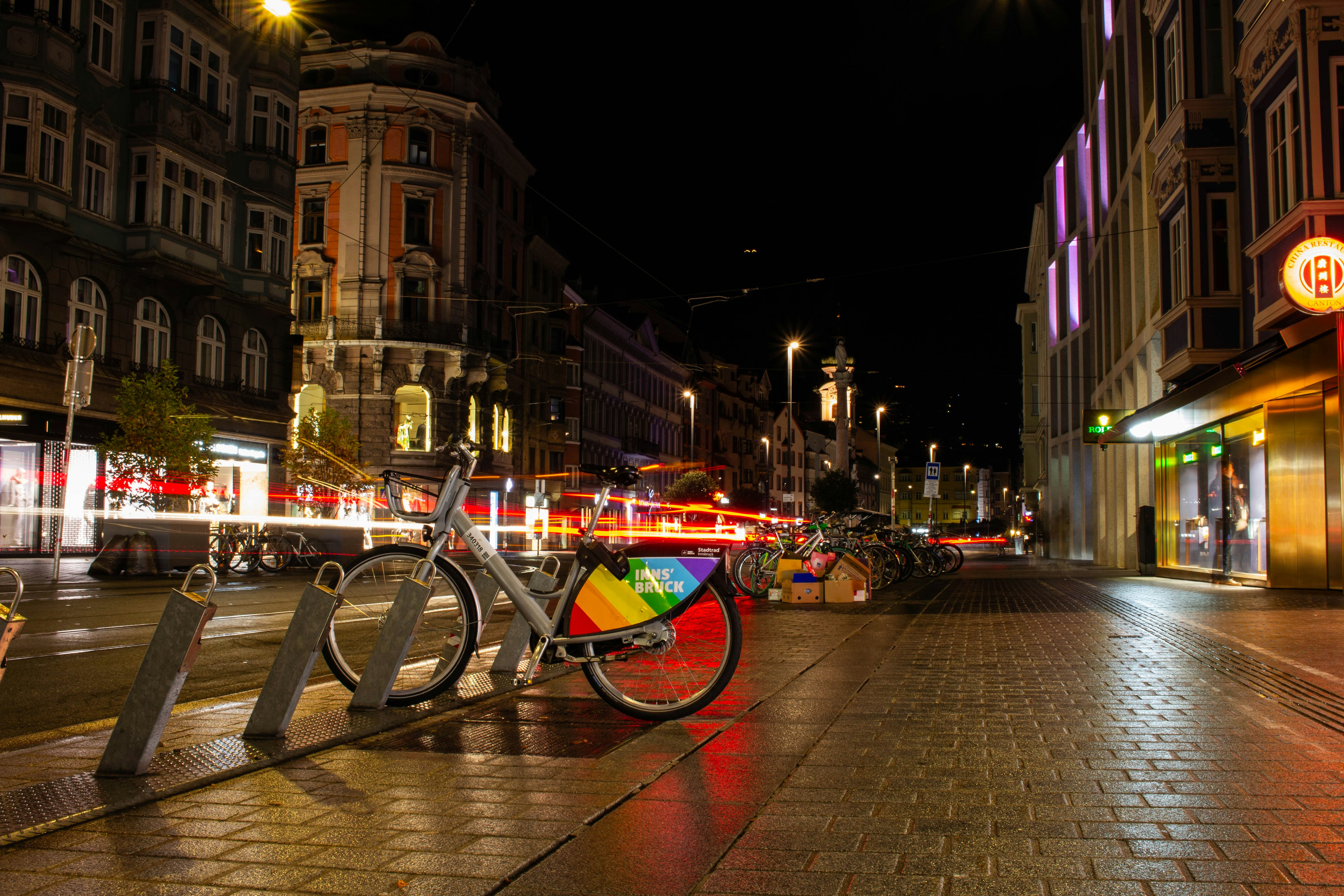 Neon Street Bicycles: Night Pedestrian Corridor in Warm City Light