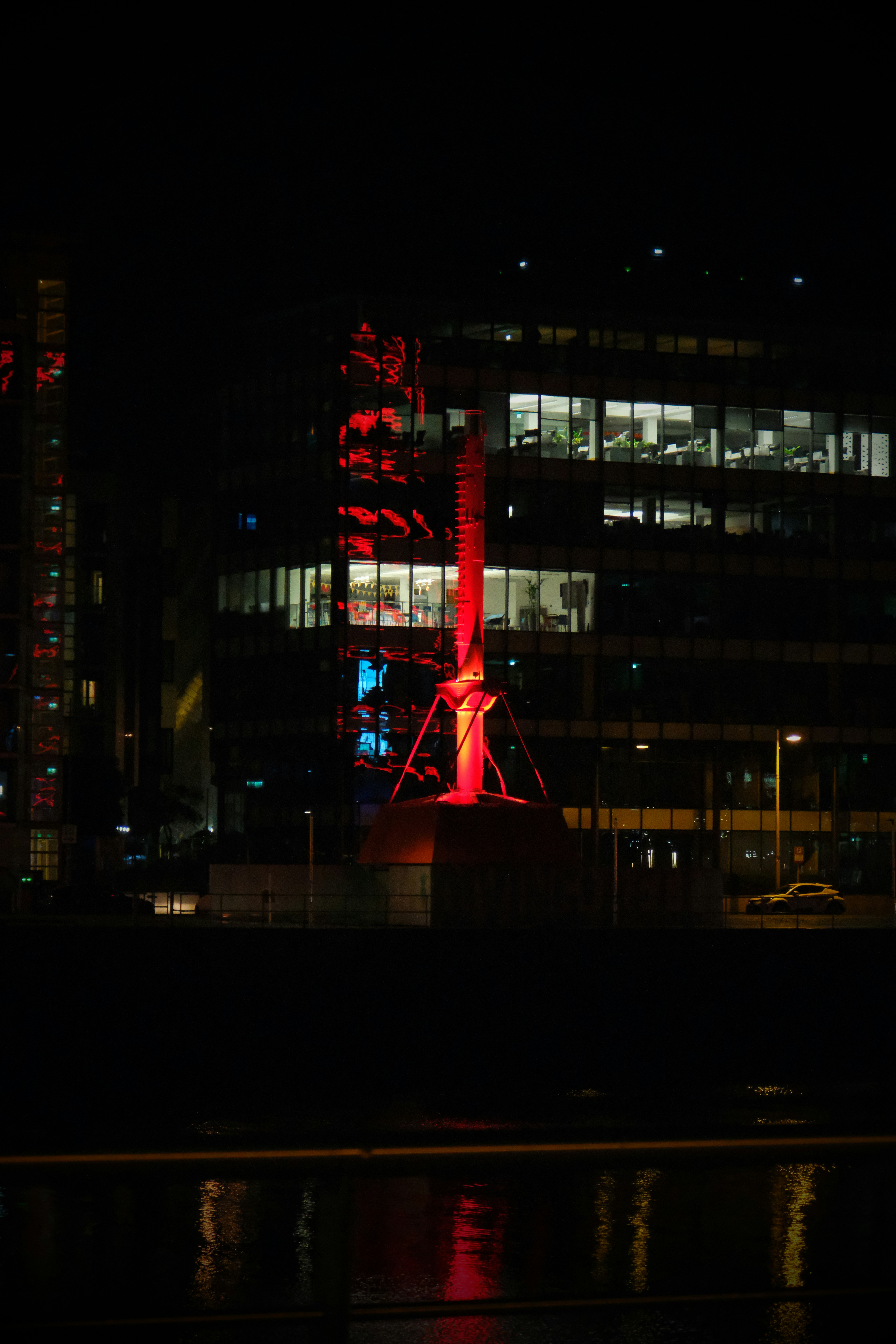 A tall building with a red light on it's side photo – Free Street ...